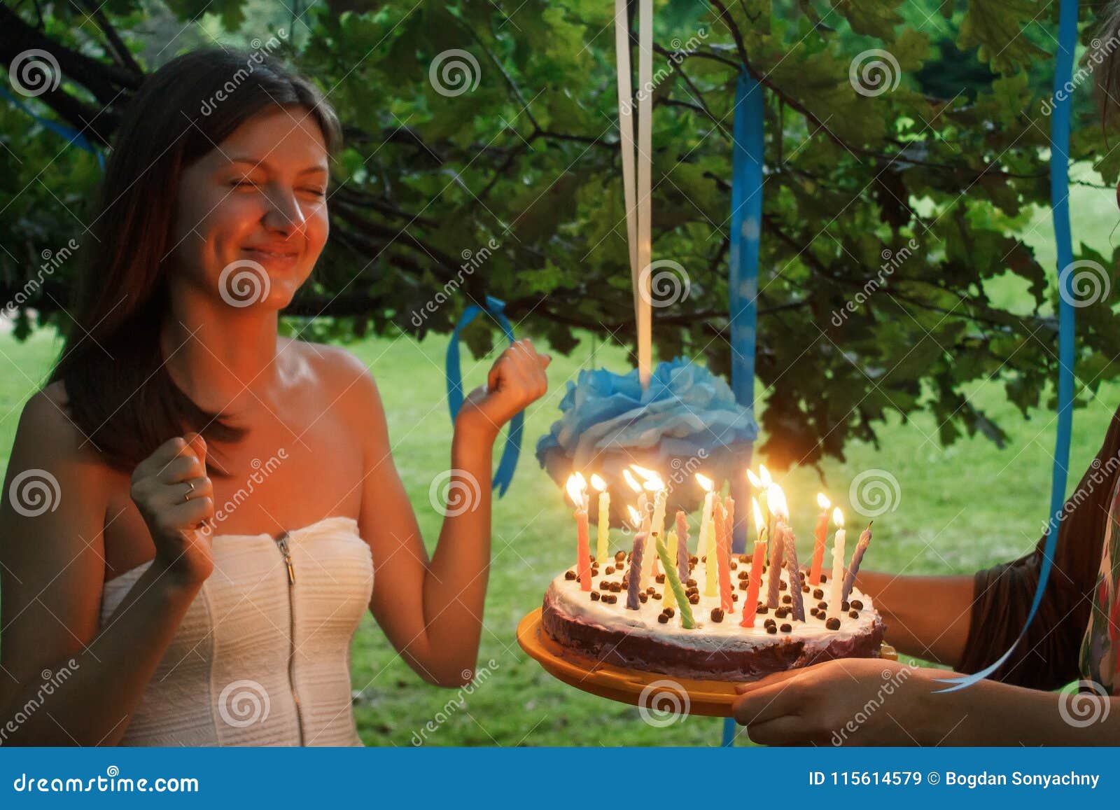 Happy Woman Making A Wish And Blowing Candles On Cake At Her Bridal