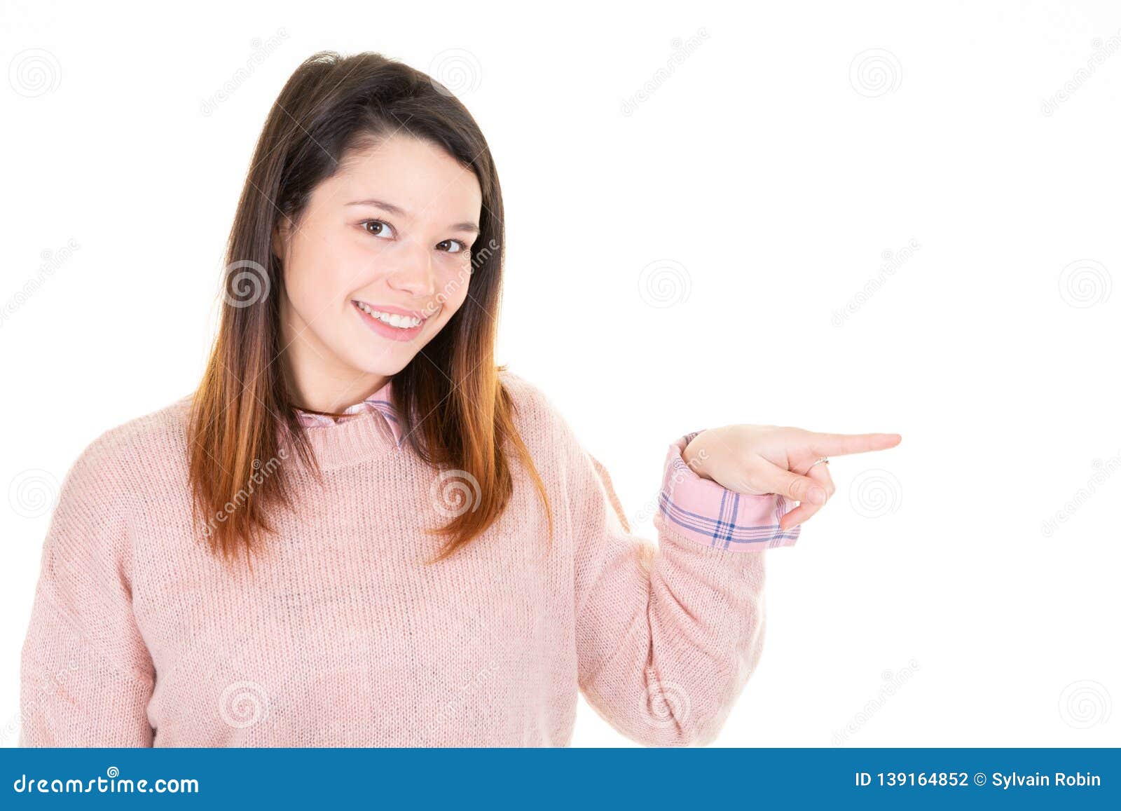 Happy Woman Pointing and Presenting at Side Looking Camera Stock Photo ...