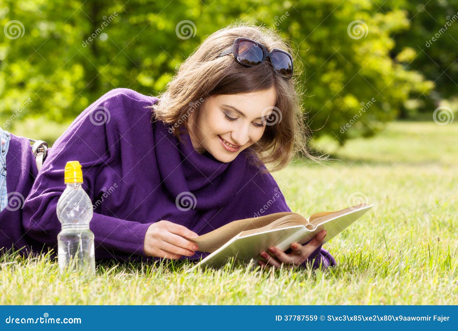 Happy Woman Reading Book Lying Down On Grass Stock Image Image Of