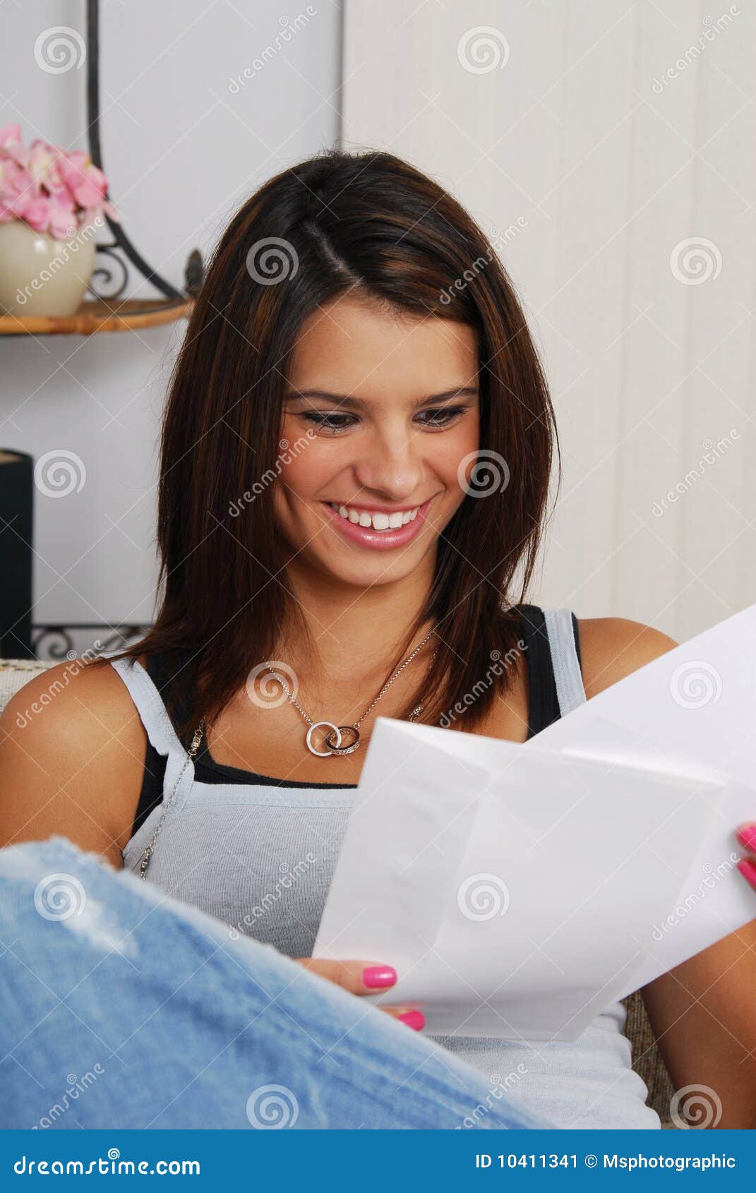 Happy woman reading a card stock image. Image of confident - 10411341