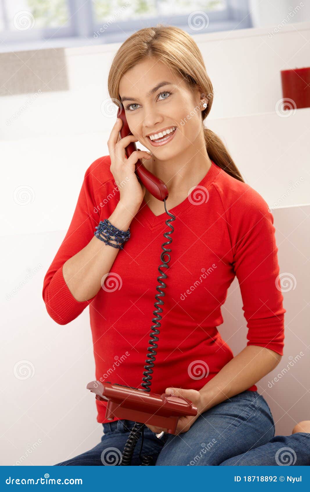Happy Woman in Red Talking on Phone at Home Stock Photo - Image of ...
