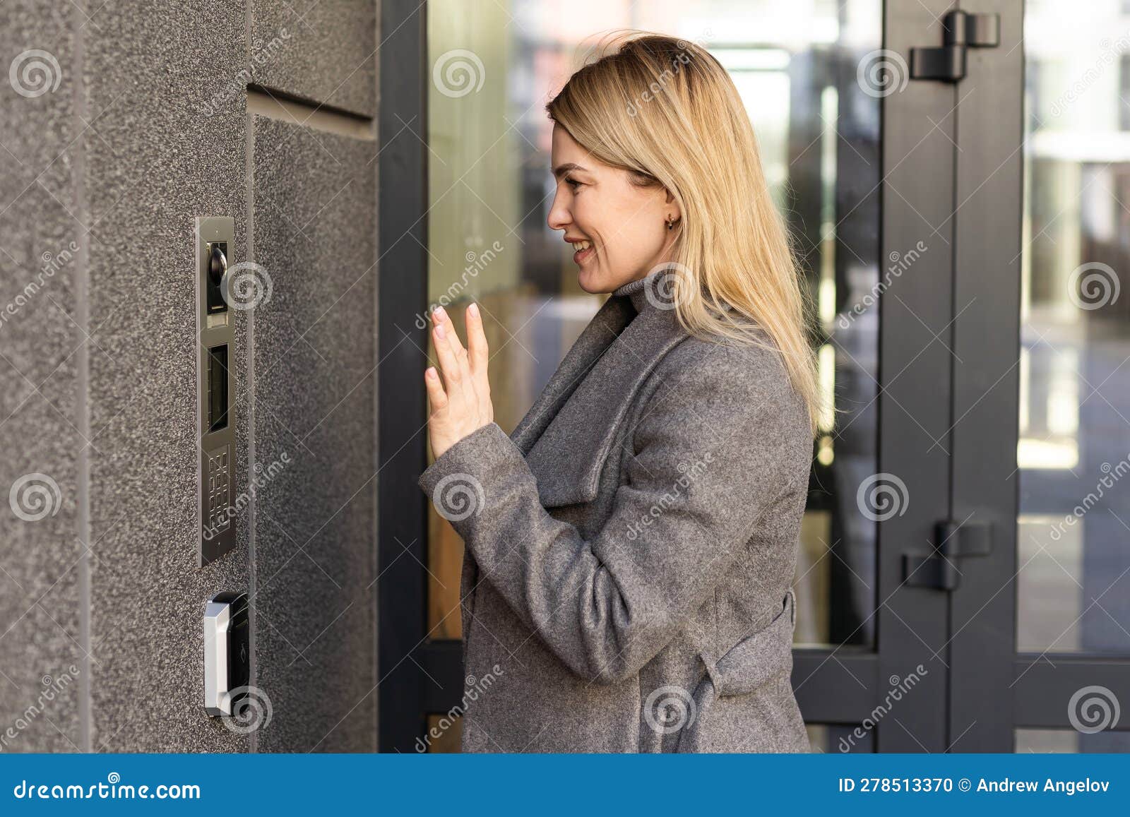 Happy Woman Ringing on Doorbell at Building Entrance. Using Intercom ...