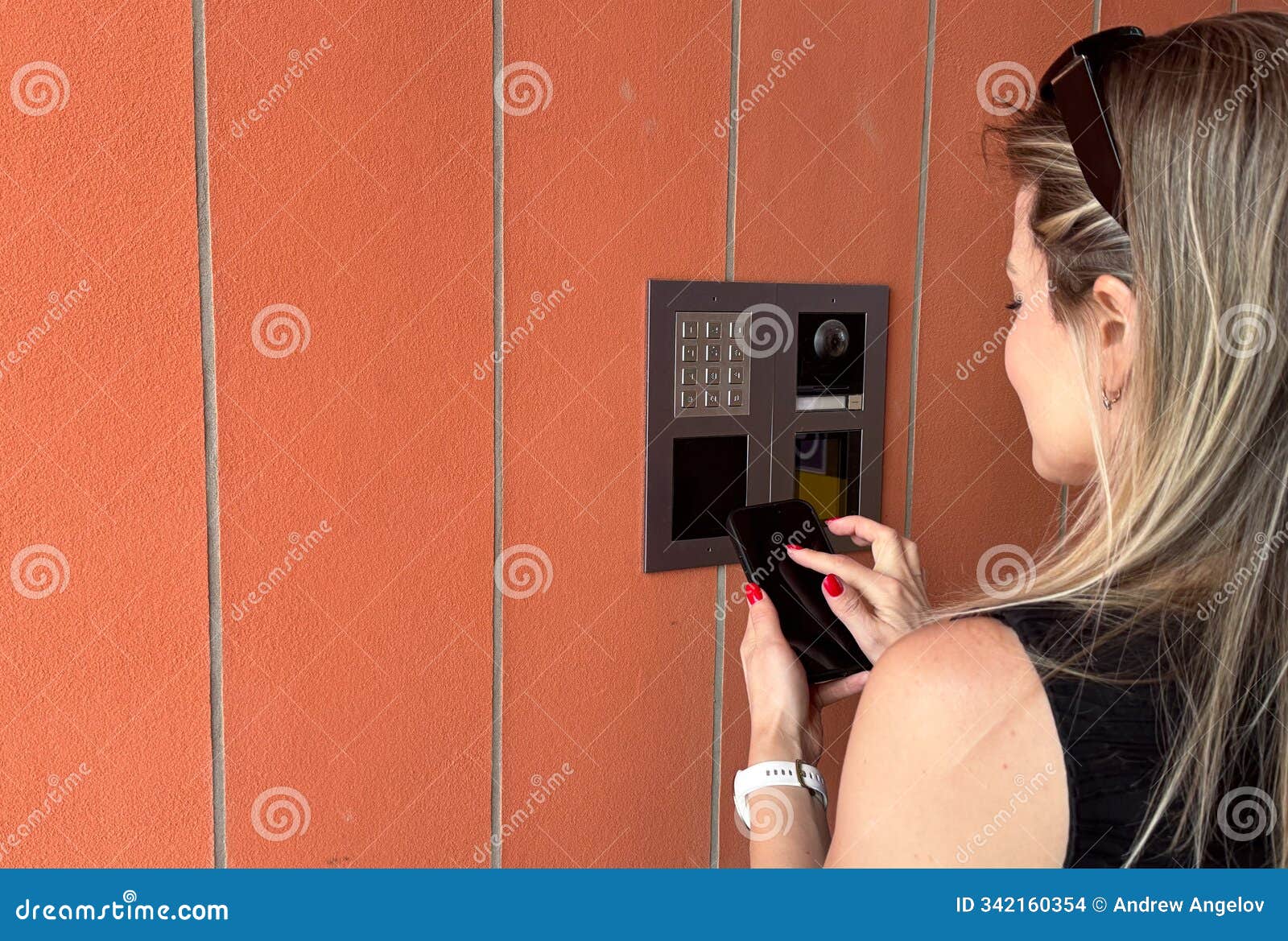 Happy Woman Ringing on Doorbell at Building Entrance. Using Intercom ...