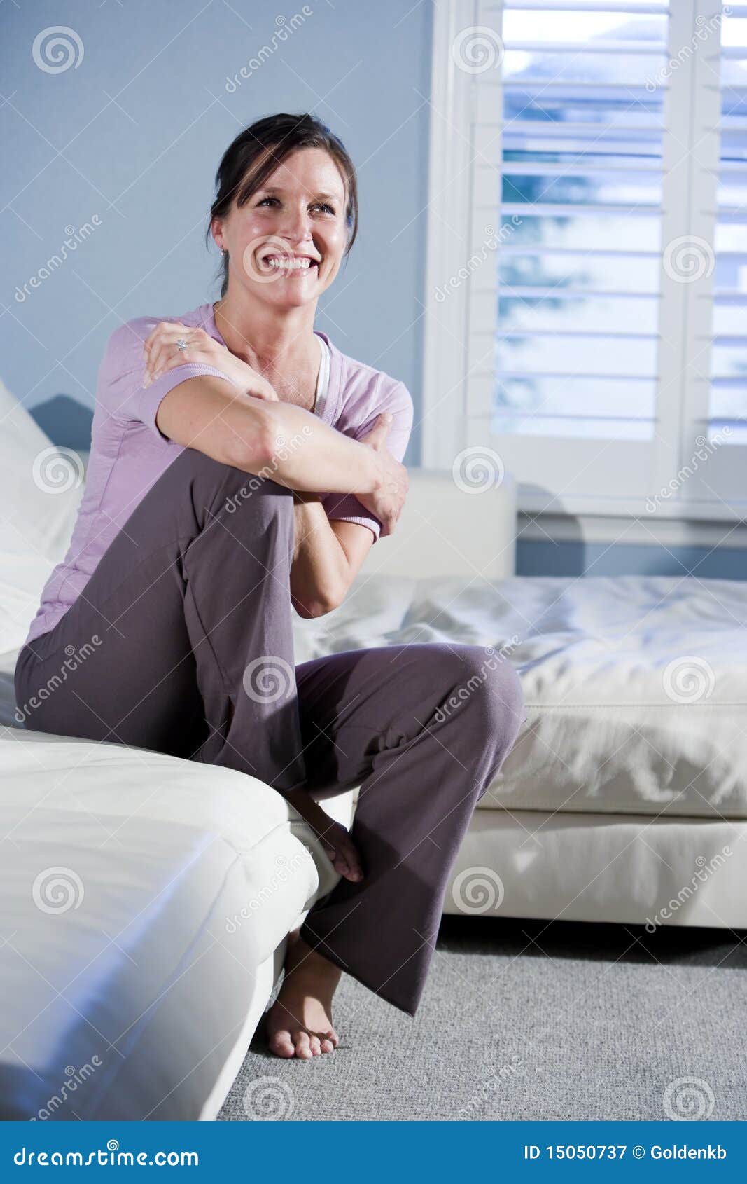 Happy Woman Sitting on Couch Smiling Stock Image - Image of window ...