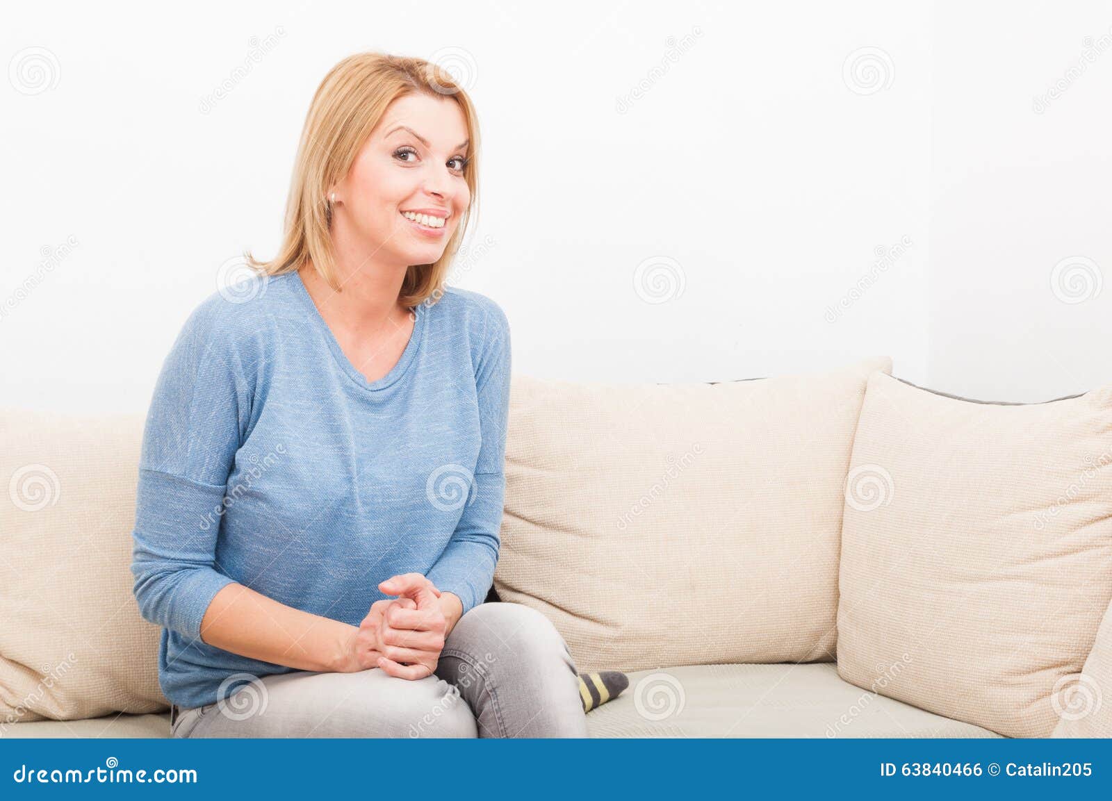 Happy Woman Smiling on a Couch or Sofa Stock Photo - Image of apartment ...