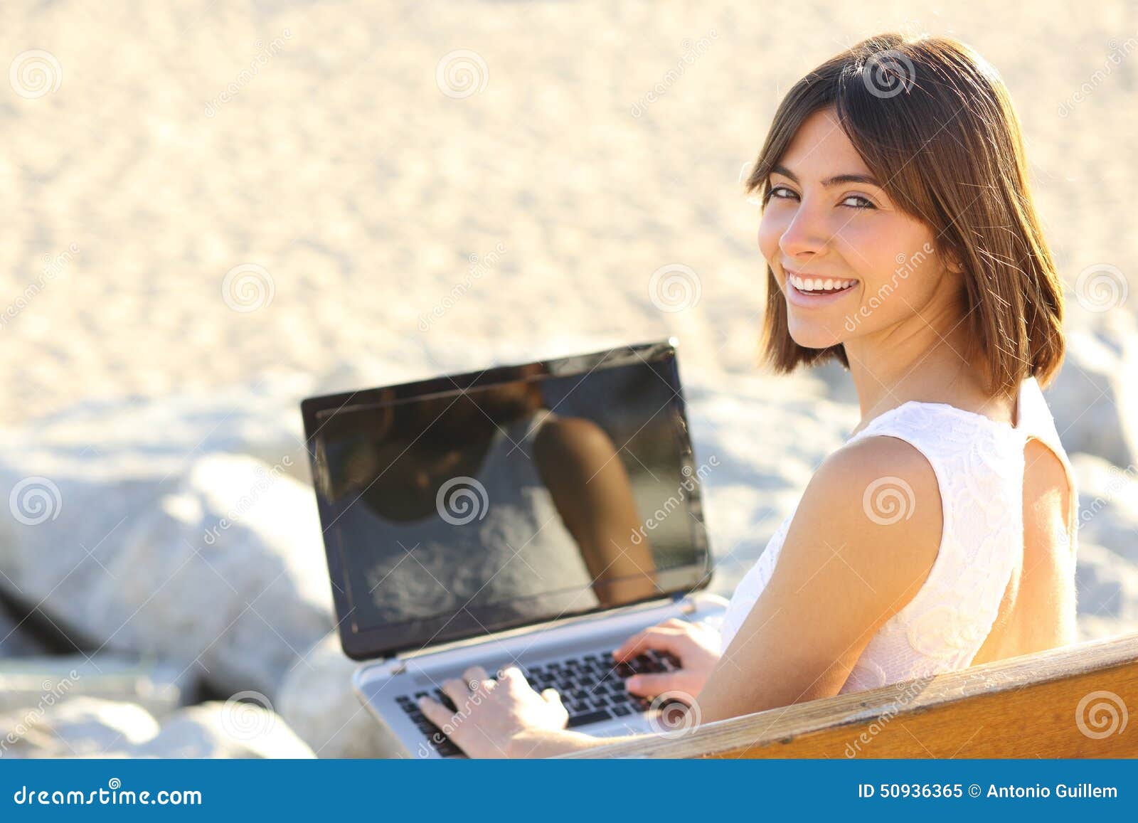 Happy Woman Typing on a Laptop and Looking at Camera Stock Image ...