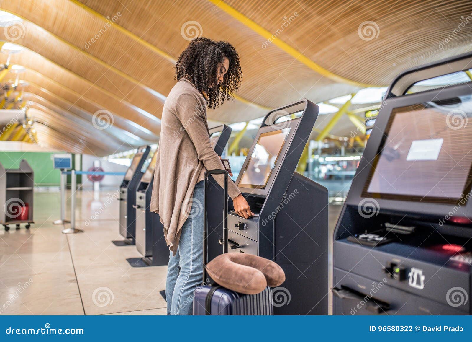 Happy Woman Using the Check-in Machine at the Airport Getting Th Stock ...