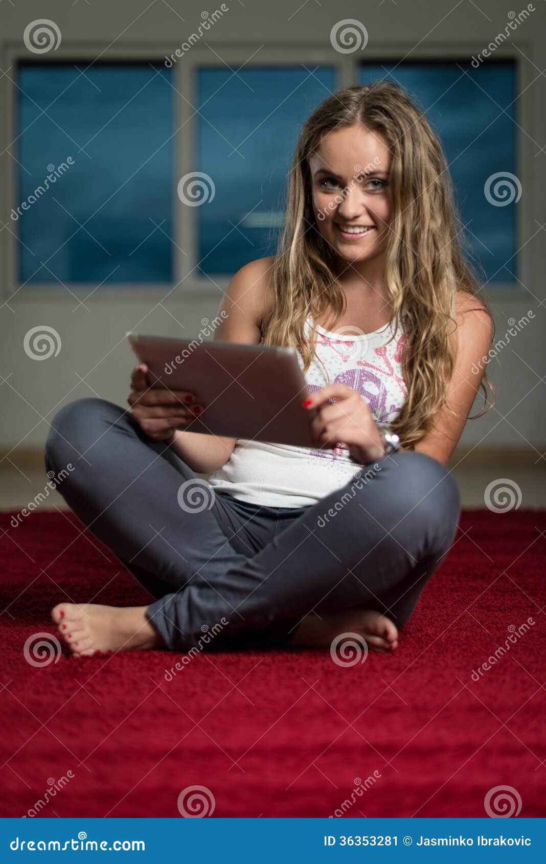 Happy Woman Using IPad while Siting on Carpet Stock Image - Image of ...