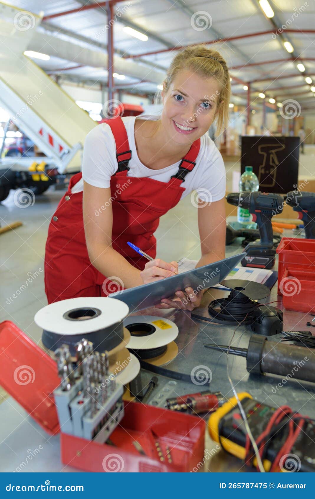 Happy woman in workshop stock image. Image of professional - 265787475