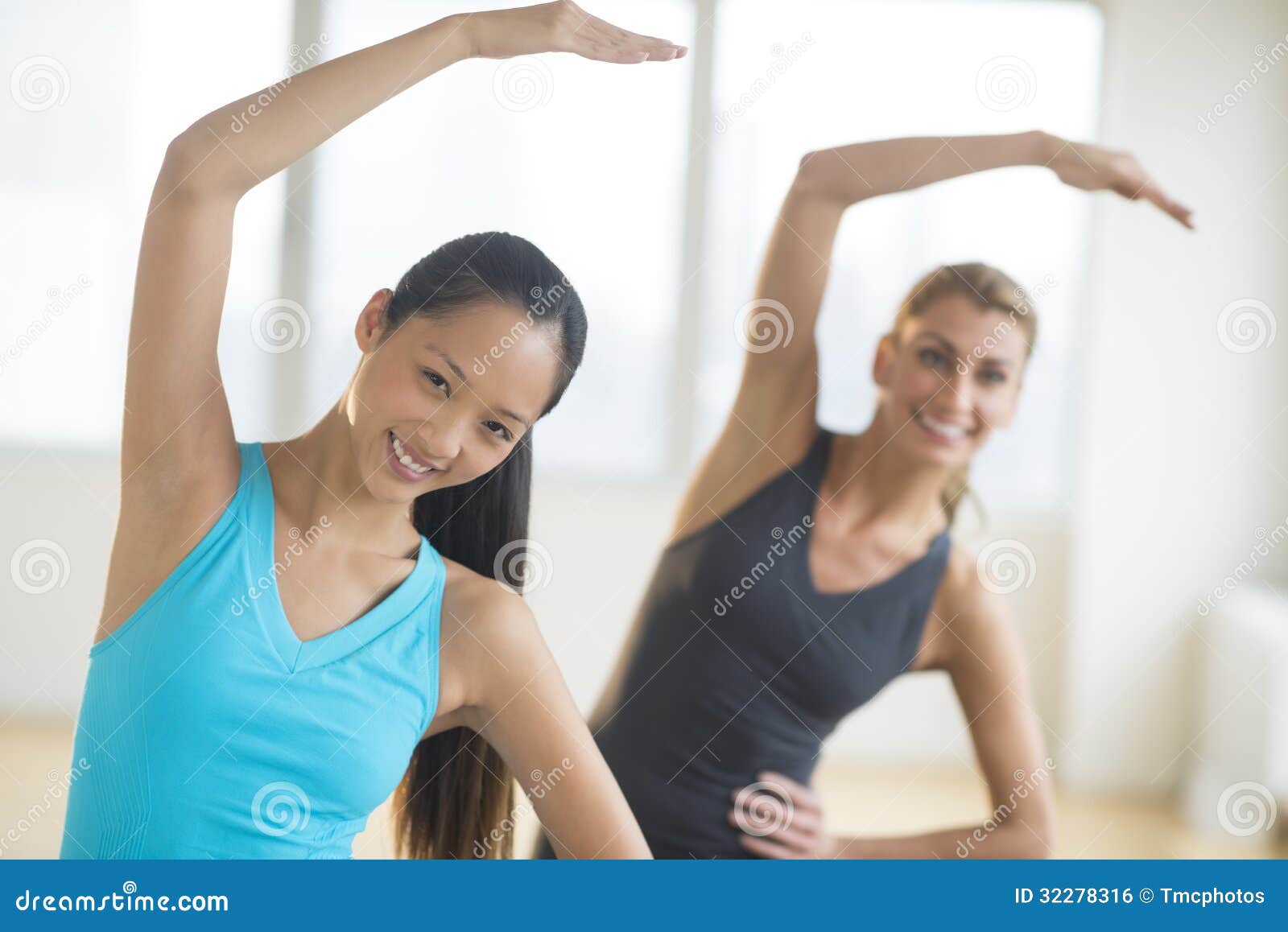 Happy Women Doing Stretching Exercise at Gym Stock Photo - Image of ...