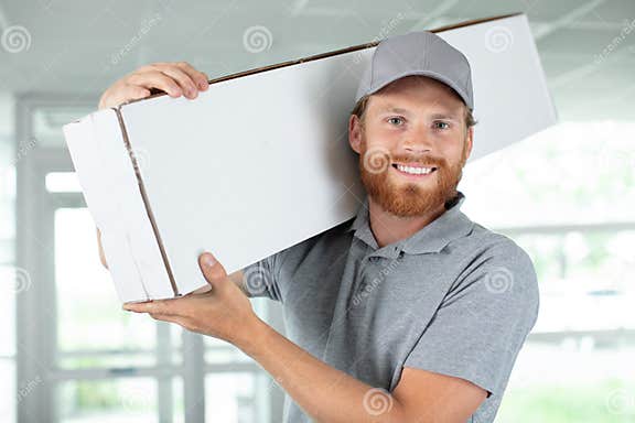 Happy worker carrying box stock photo. Image of distribution - 286753596