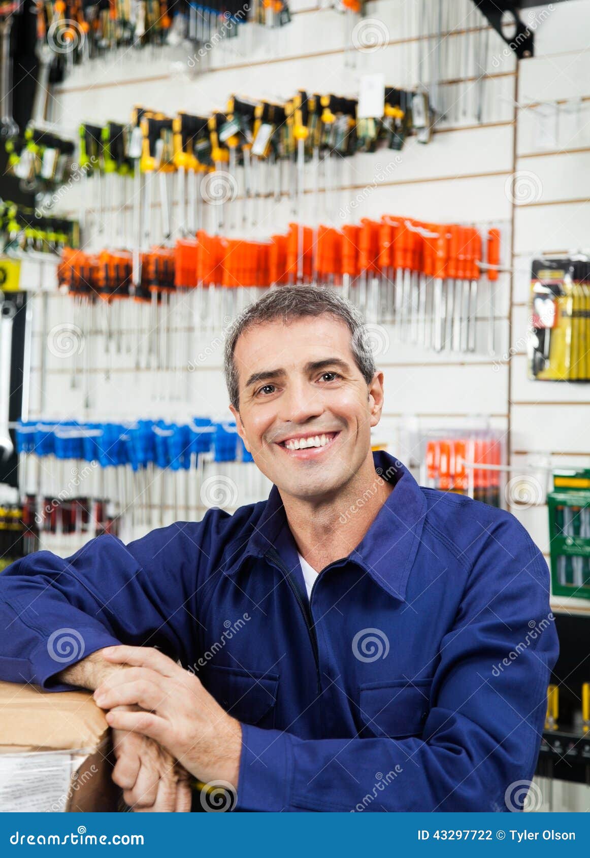 Happy Worker in Hardware Shop Stock Photo - Image of blue, male: 43297722