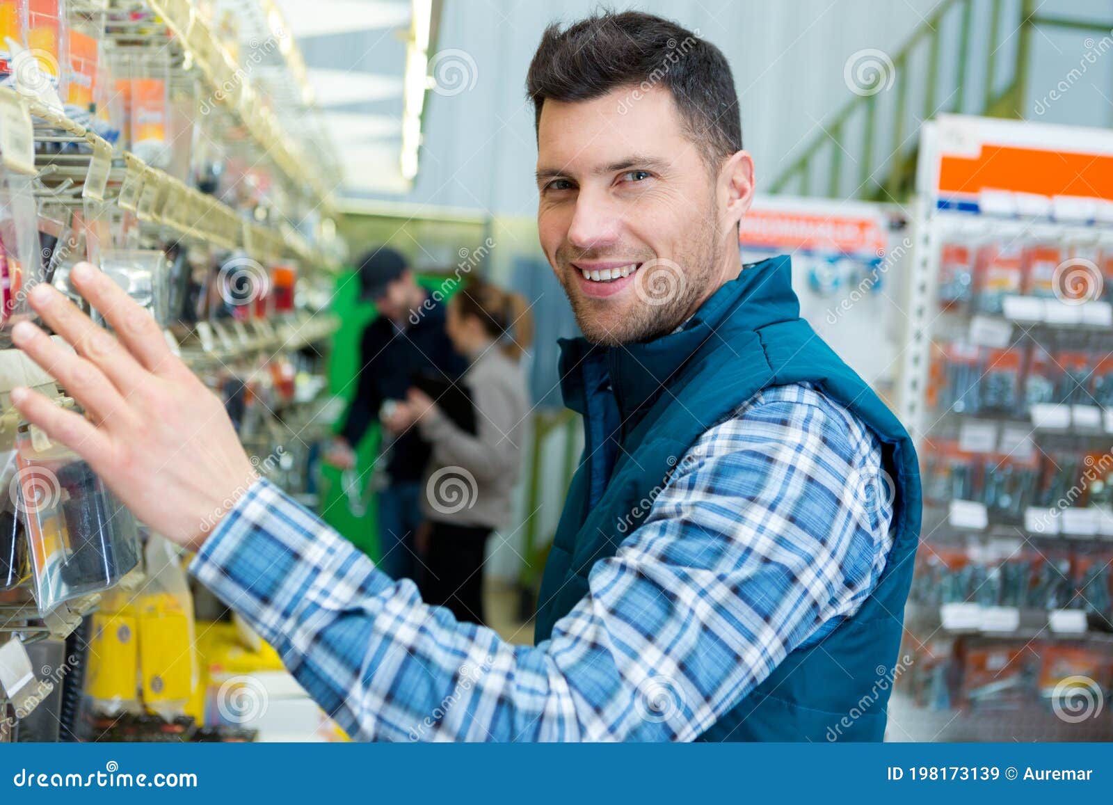 Happy worker in tool store stock image. Image of clerk - 198173139