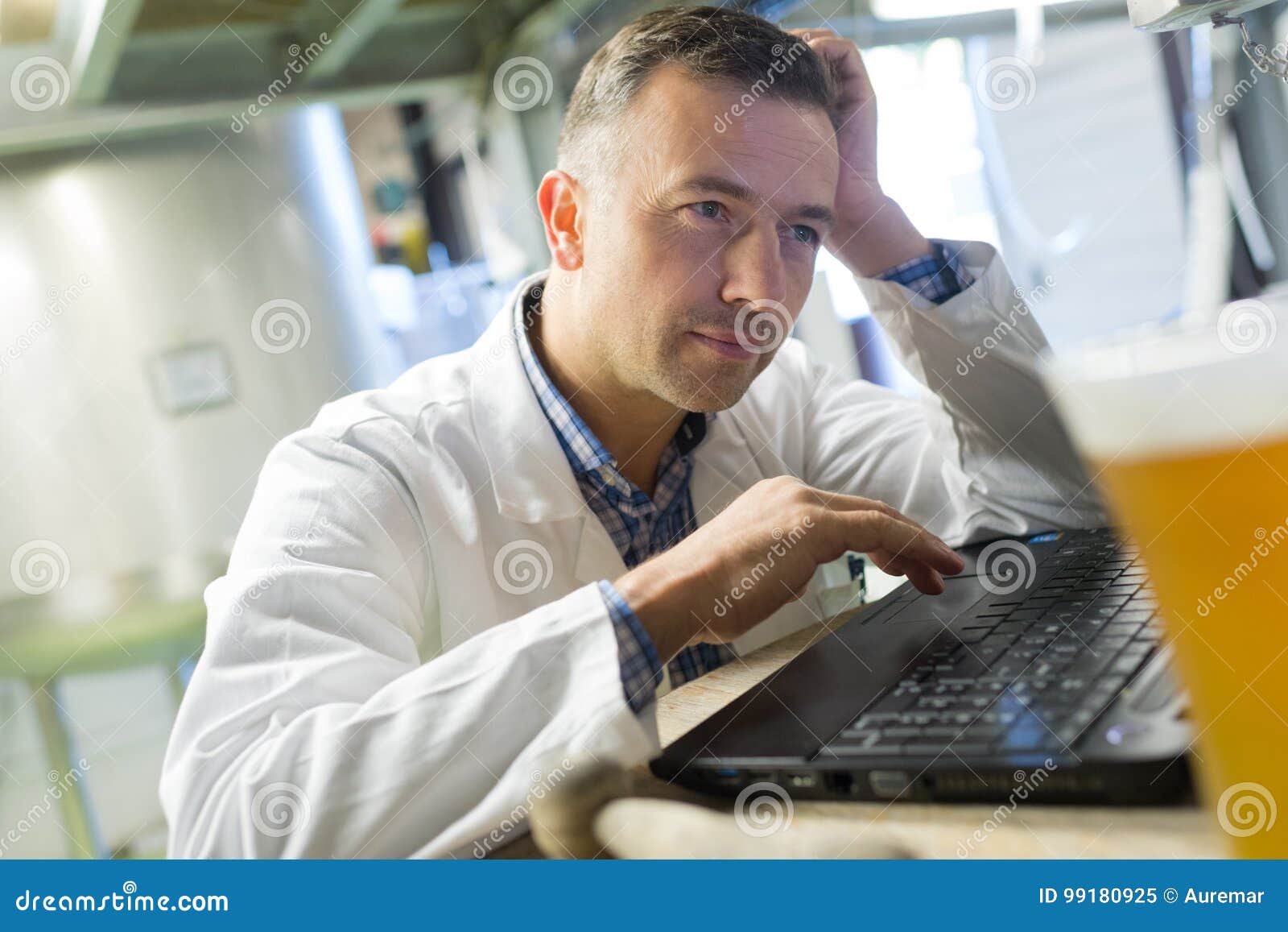 Happy Worker in White Coat Checking Computer at Factory Stock Image ...