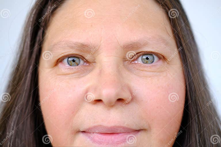 Happy 50 Year Old Woman With Gentle Smile On Lips Maintaining