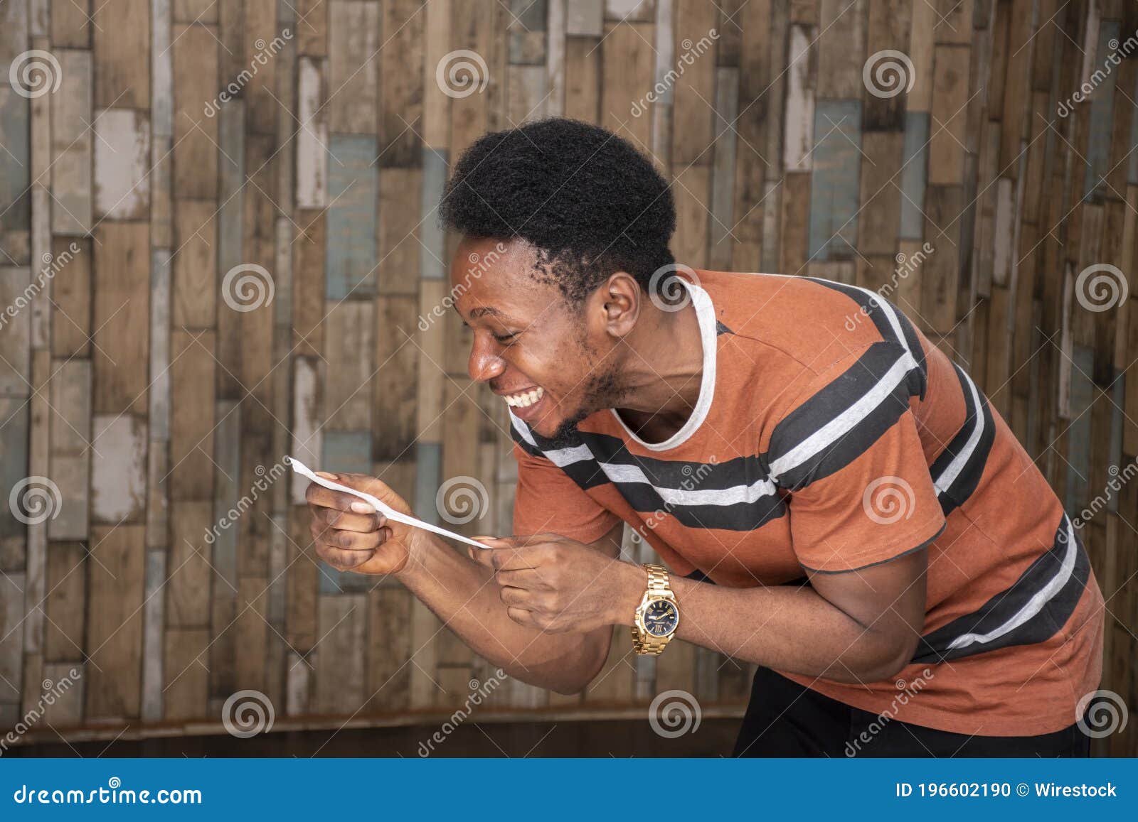 Happy Young African Man Looking at a Piece of Paper Stock Photo - Image ...