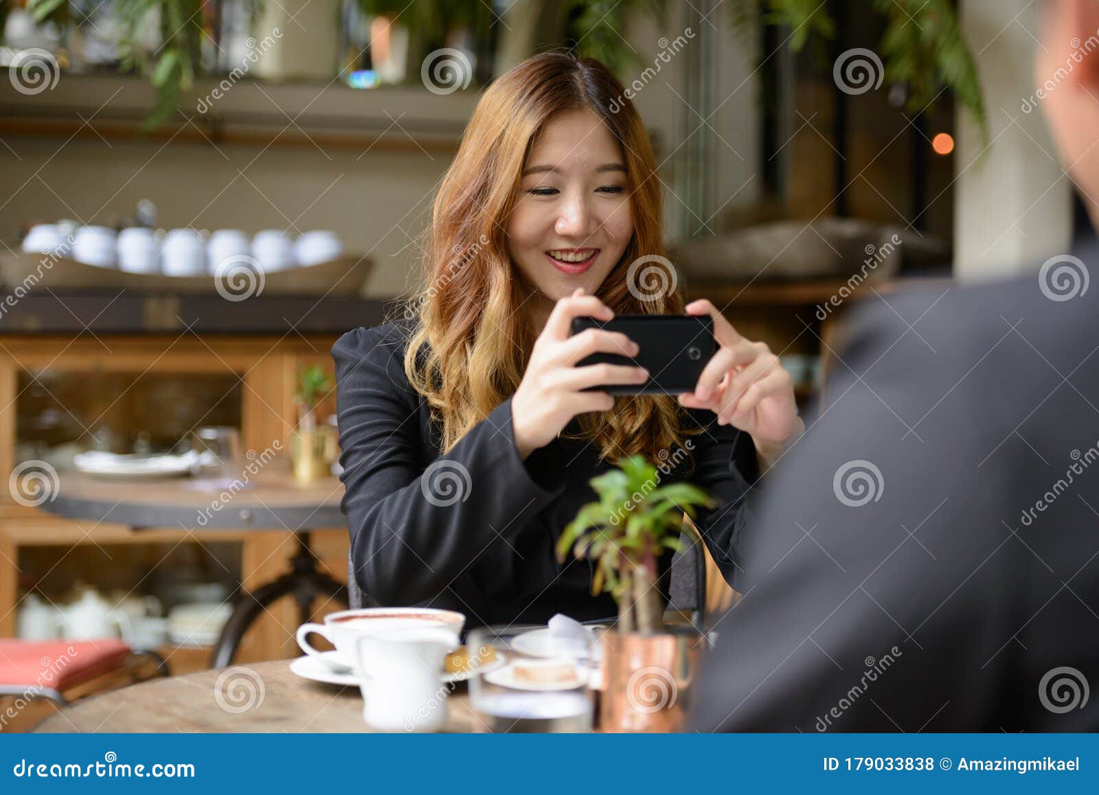 Happy Young Asian Business Couple Together at the Coffee Shop with ... Happy Young Asian Business Couple Together at the Coffee Shop with ...