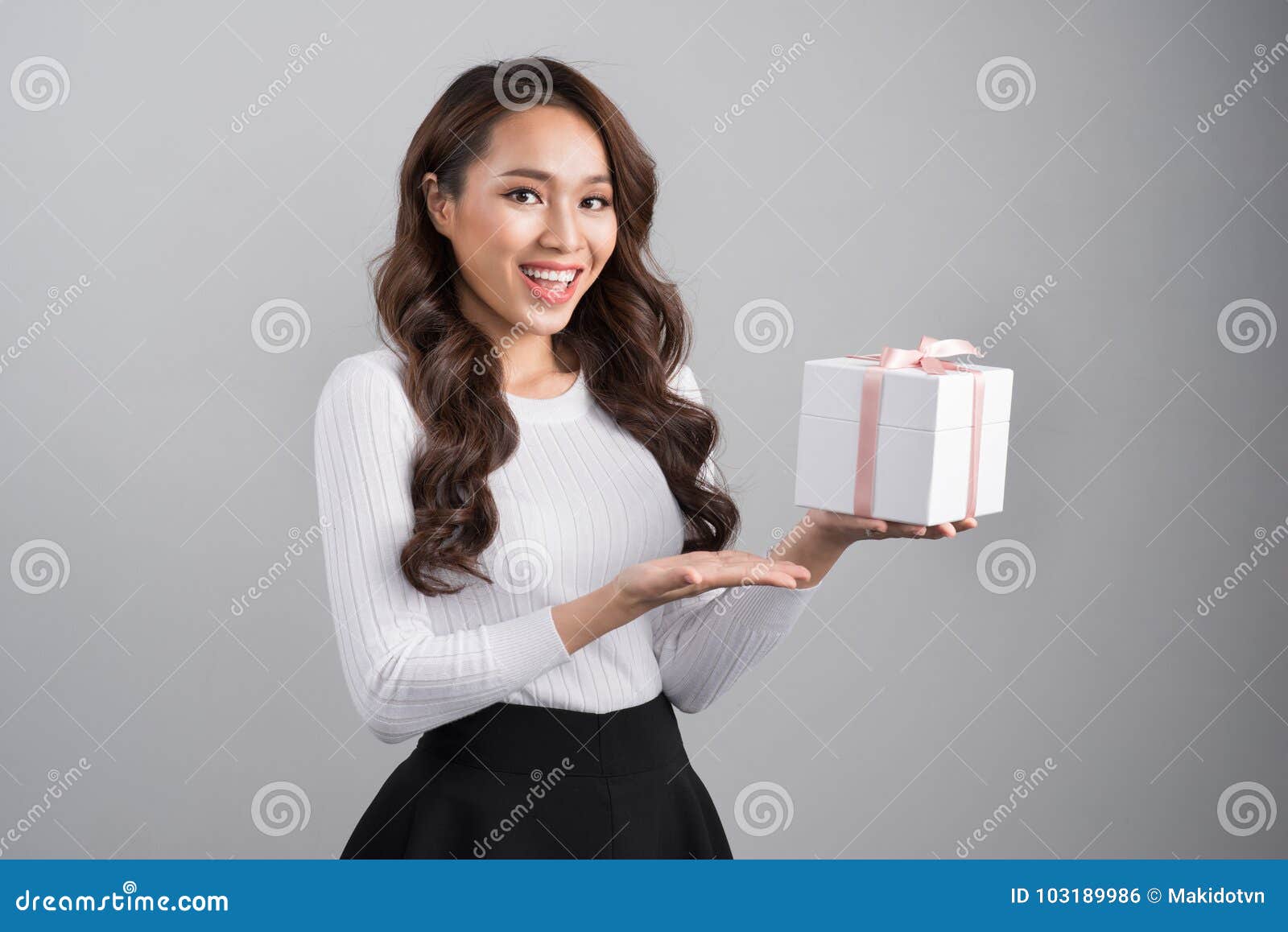 Happy Young Asian Woman Giving Gift Box Over Gray Background Stock ... Happy Young Asian Woman Giving Gift Box Over Gray Background Stock ...