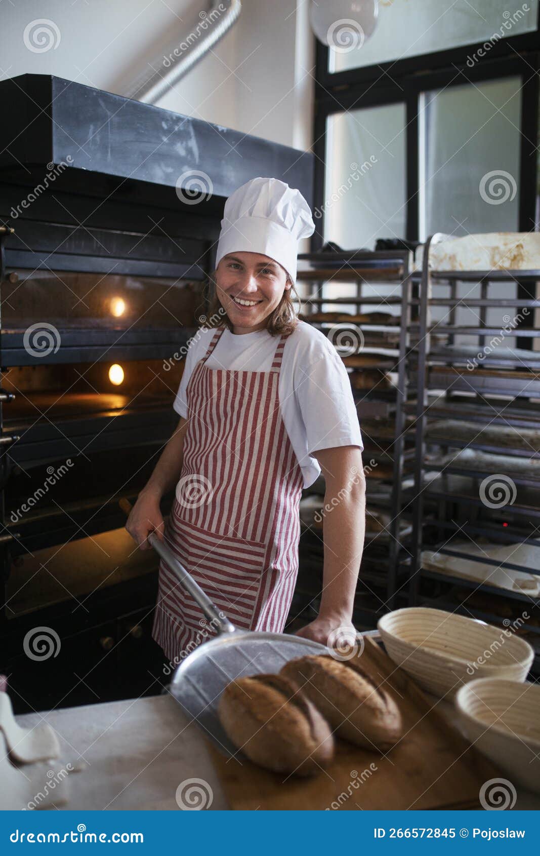 Happy Young Baker with Fresh Bread, in Bakery. Stock Image - Image of ...