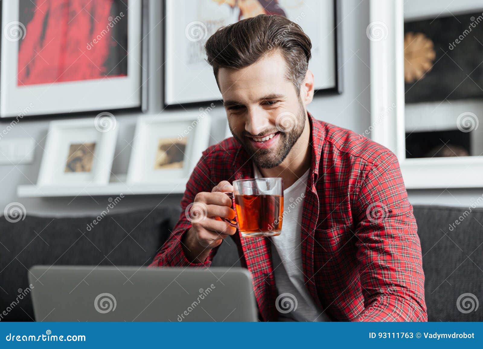 Happy Young Bearded Man Using Laptop Computer Drinking Tea Stock Image ...