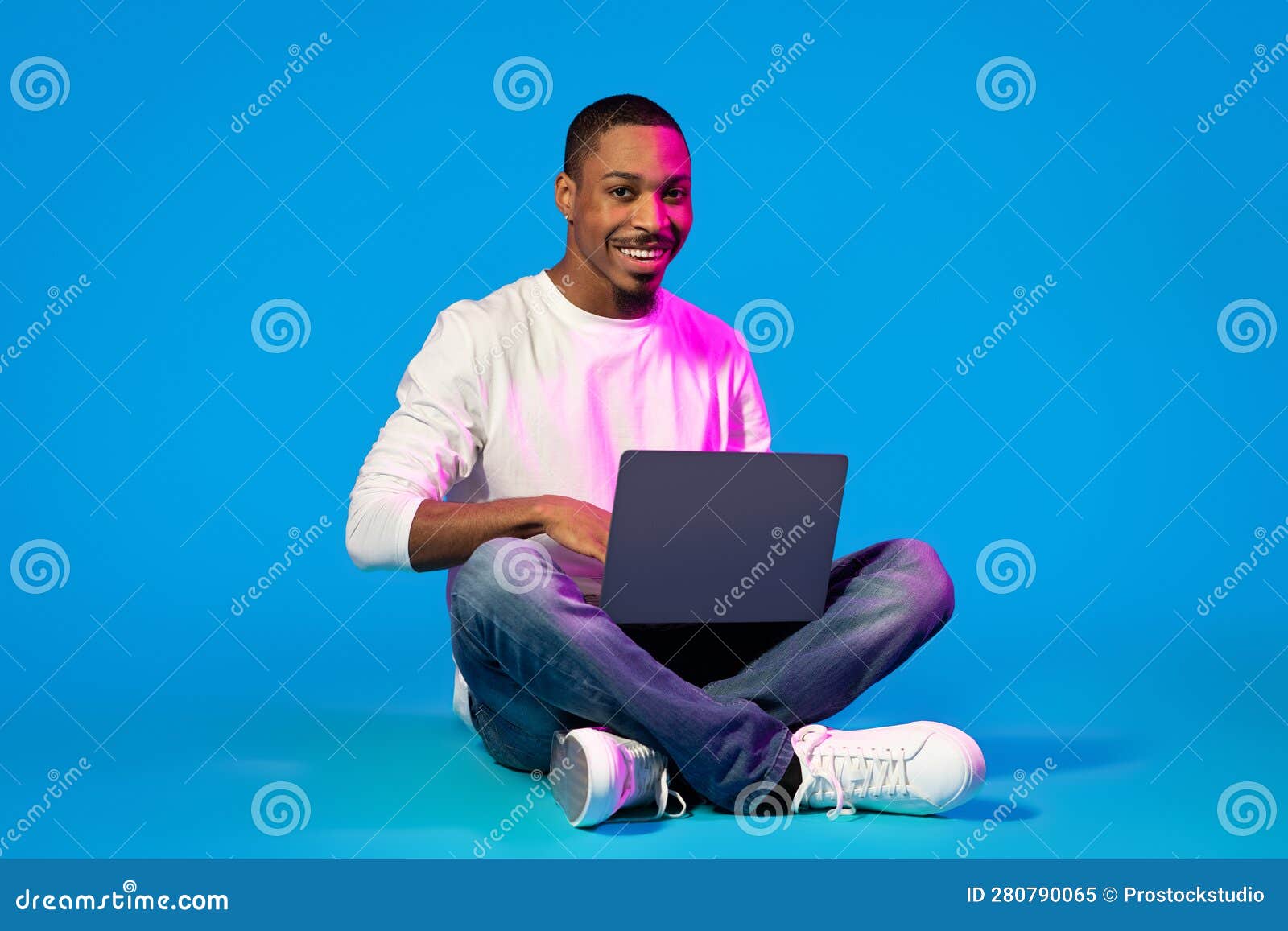 Happy Young Black Man Using Laptop on Blue Background Stock Image ...