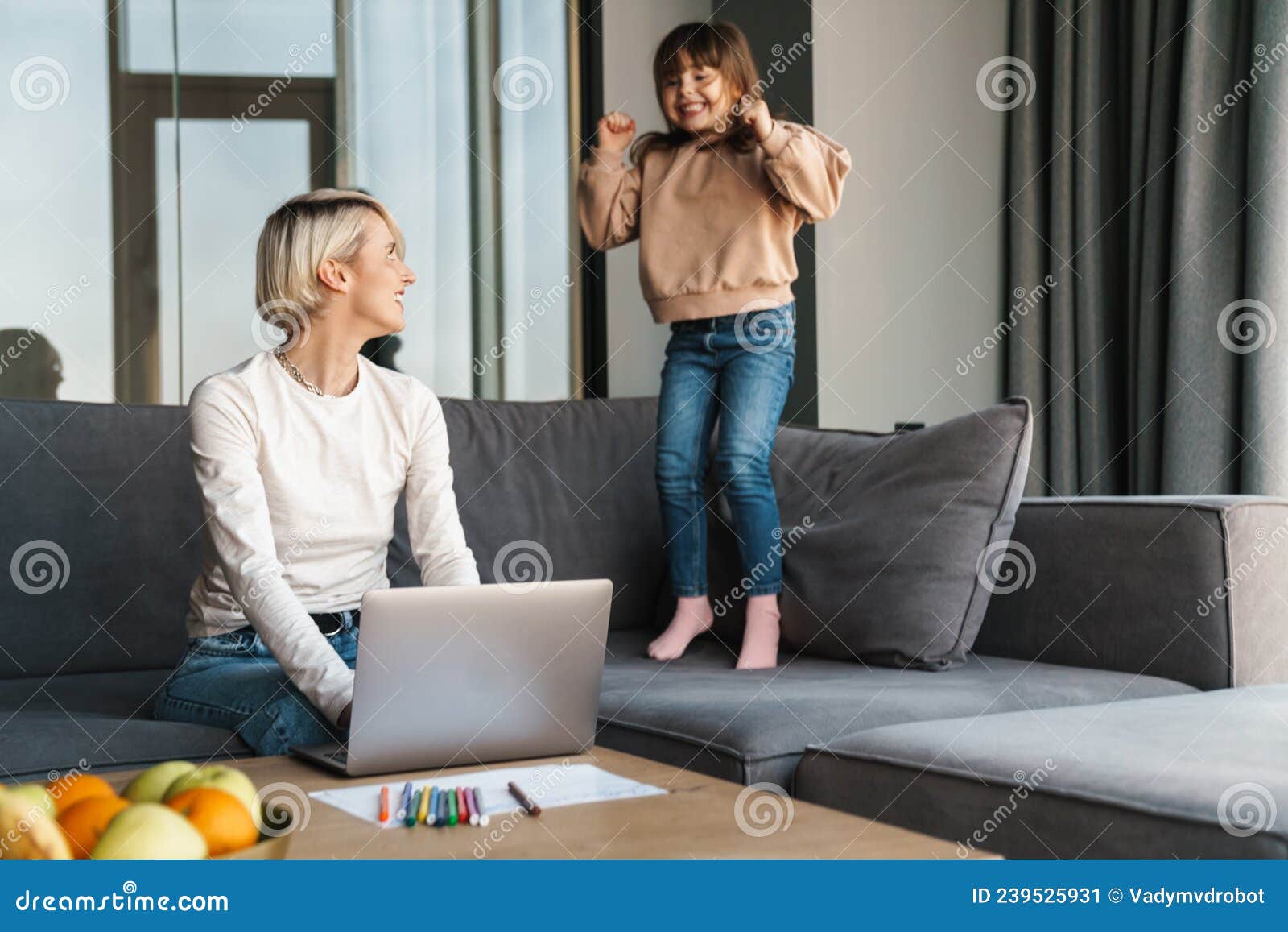 Happy Young Blonde Mother Working On Laptop Computer Stock Image