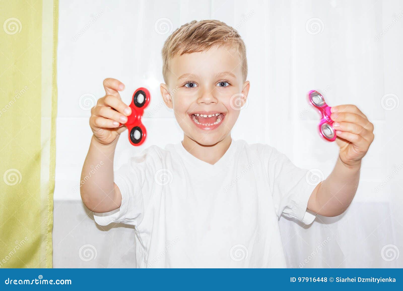 Happy Young Boy Holding Two Fidget Spinners. Stock Photo - Image of ...