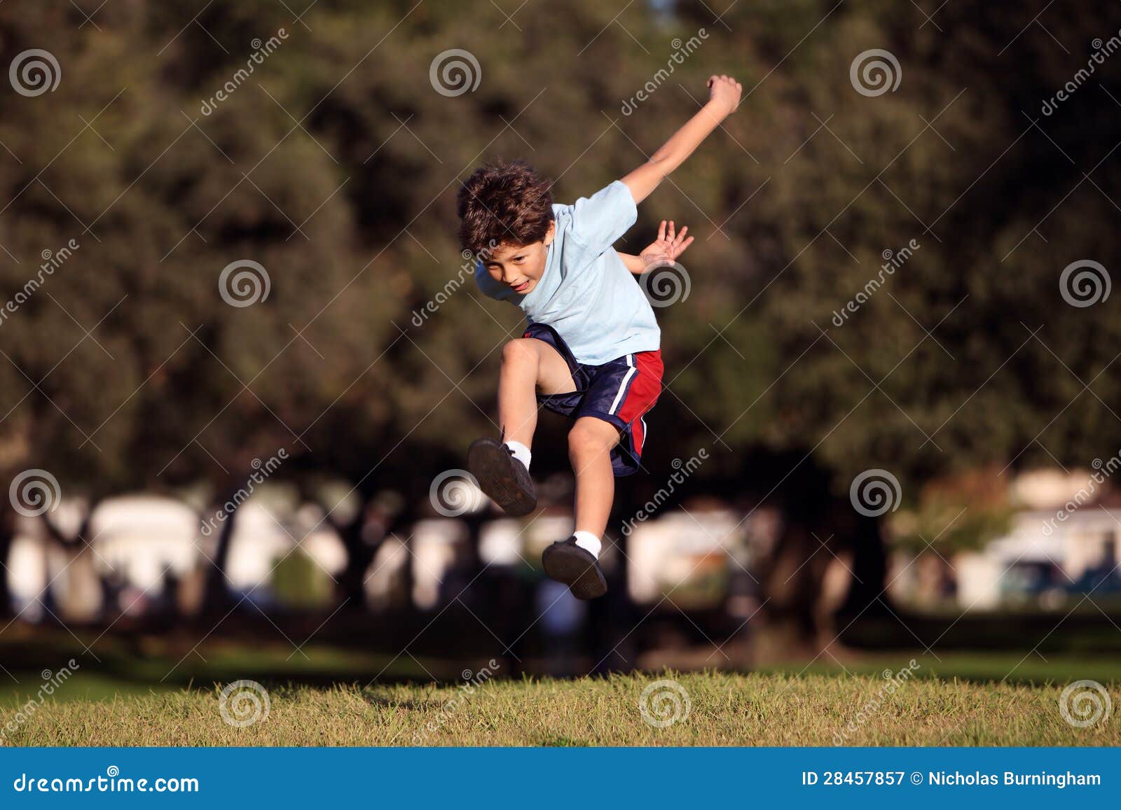 Happy Young Boy Jumping and Playing in the Park Stock Image - Image of ...