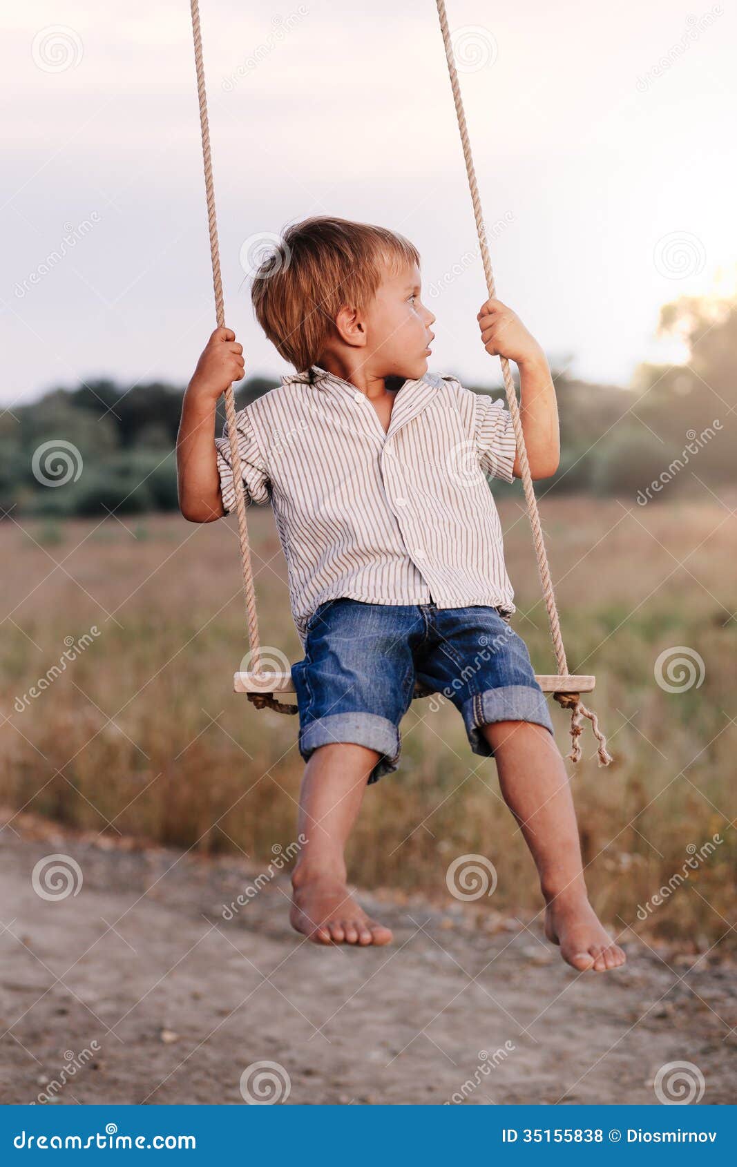 Happy Young Boy Playing on Swing in a Park Stock Photo - Image of happy ...