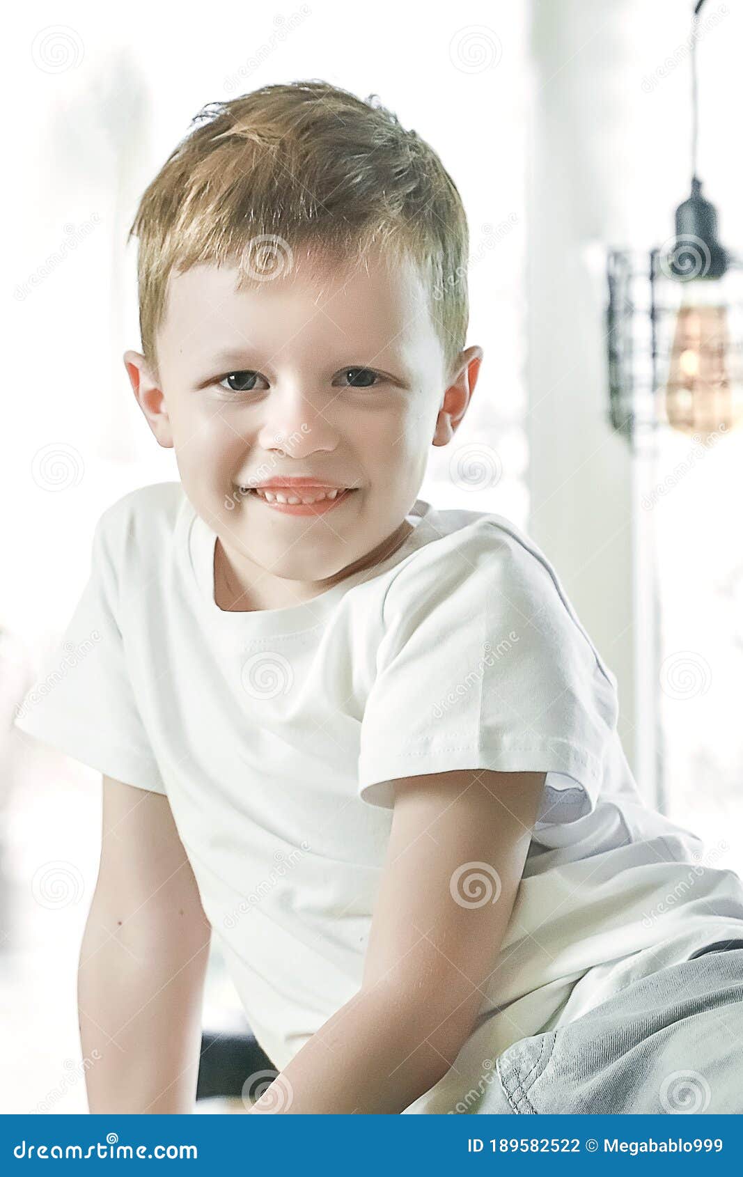 Happy Young Boy with Smile on His Face in Bright Interior Stock Photo ...