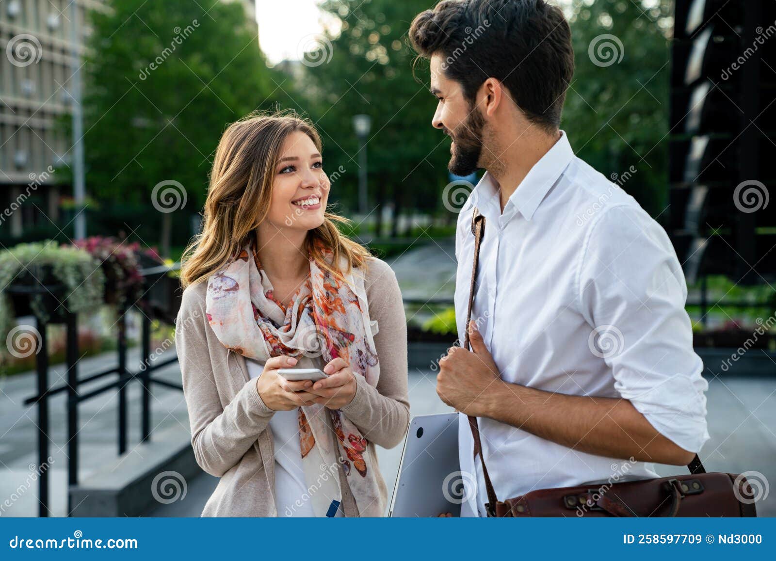 Happy Young Business People Chatting and Using Digital Devices Together ...