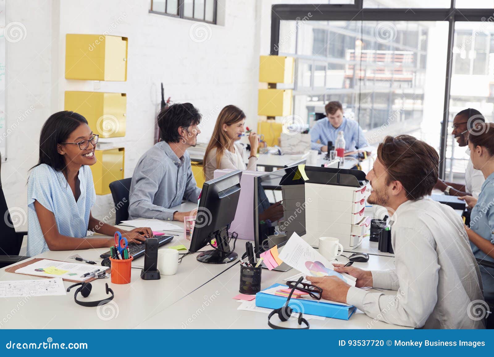 Happy Young Business Team Working in a Busy Open Plan Office Stock ...