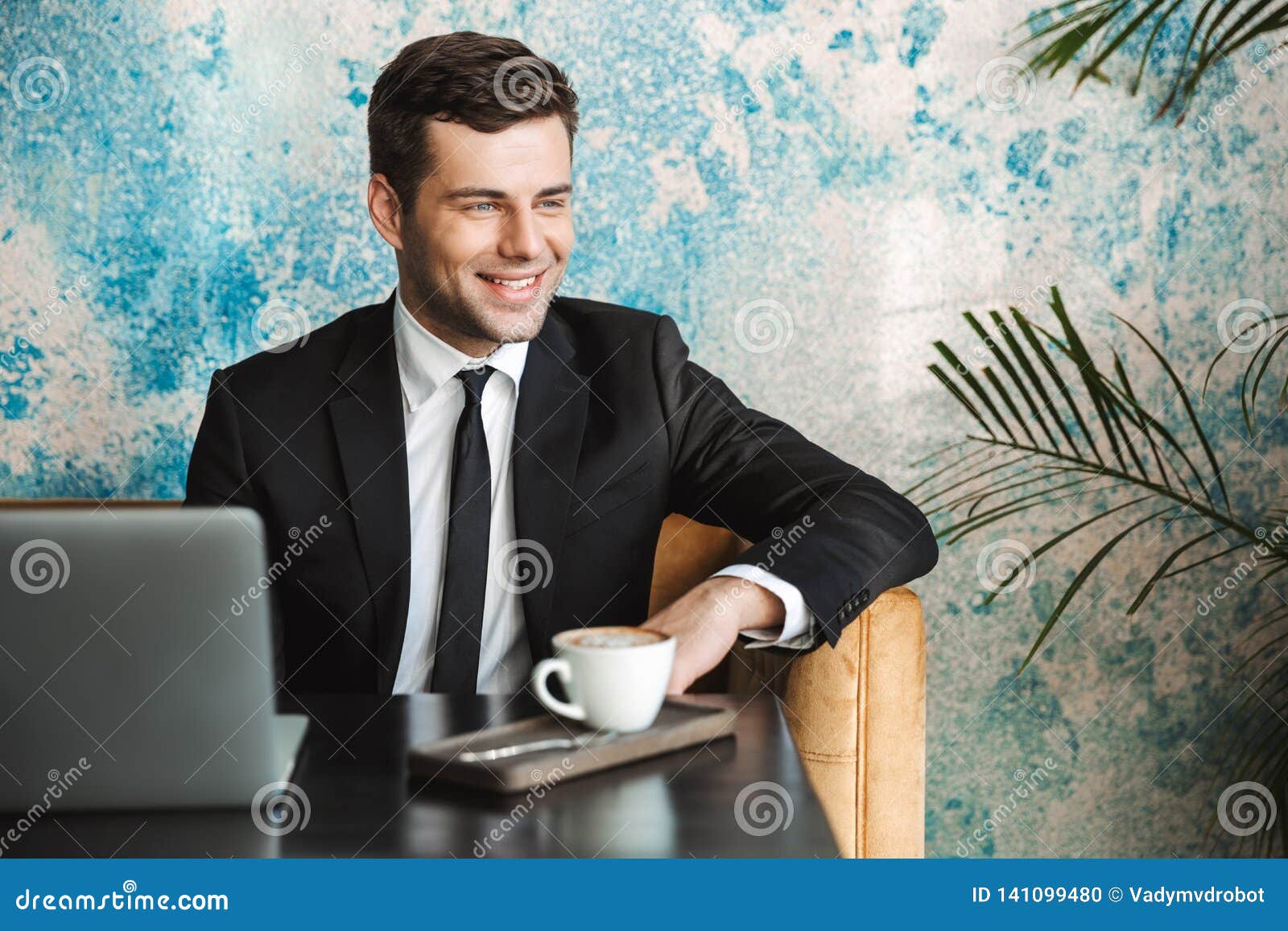 Happy Young Businessman Sitting in Cafe Using Laptop Computer Stock ...