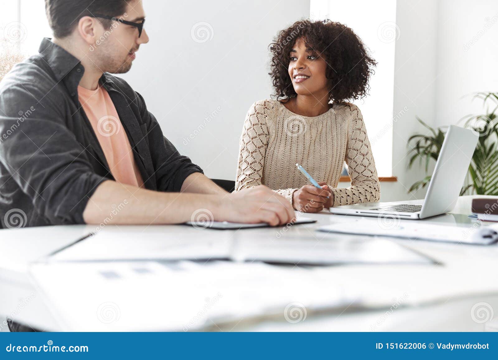 Happy Young Colleagues Talking and Looking at Each Other Stock Photo ...