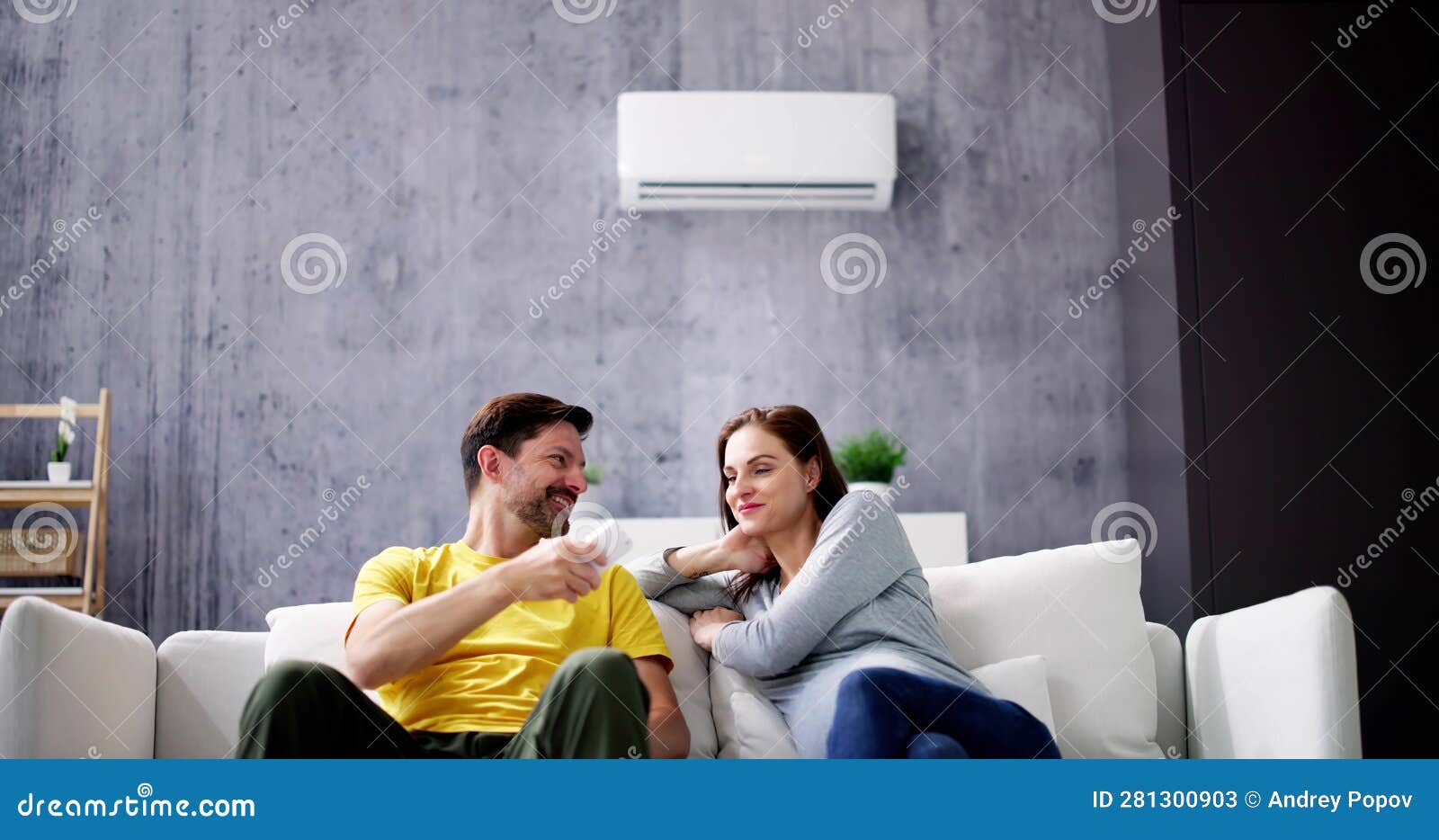 Happy Young Couple Adjusting Temperature of Air Conditioner Stock Image ...