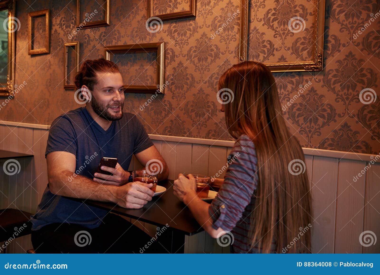 Happy Young Couple in a Bar Stock Photo - Image of reflective, gold ...