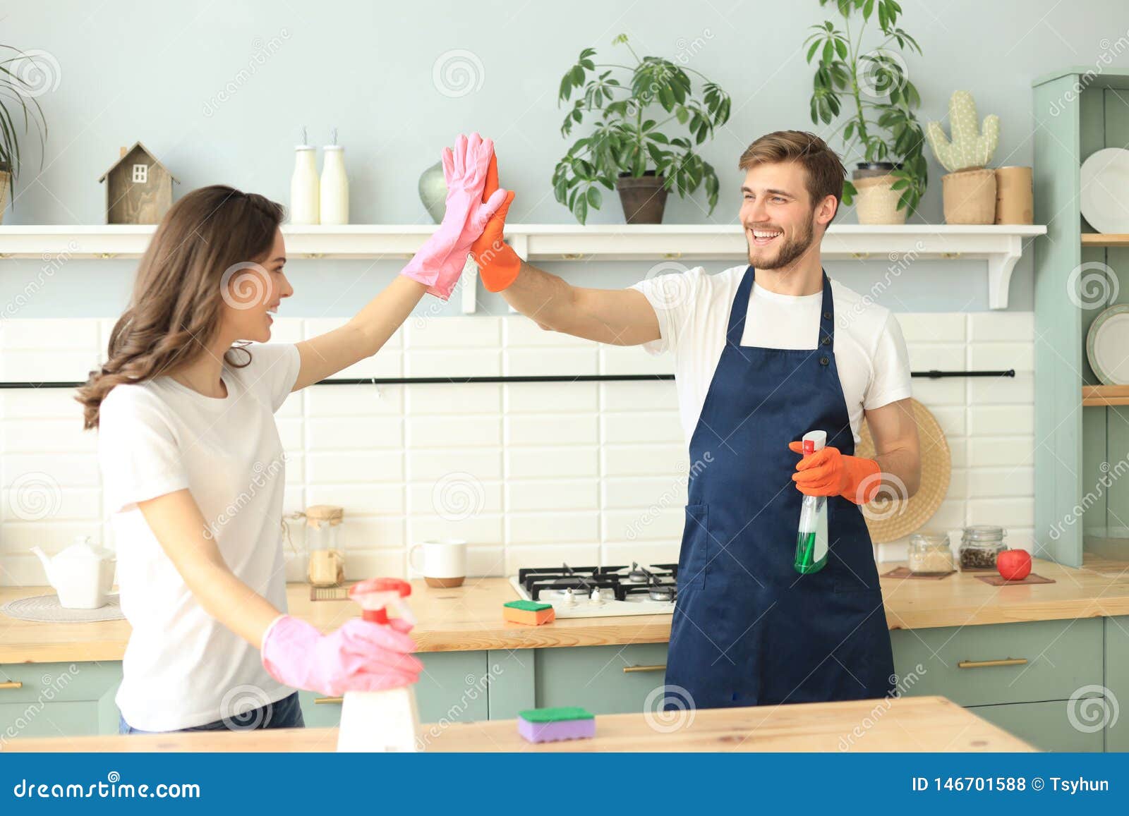 Happy Young Couple Smiling and Cleaning Kitchen Together Stock Photo ...