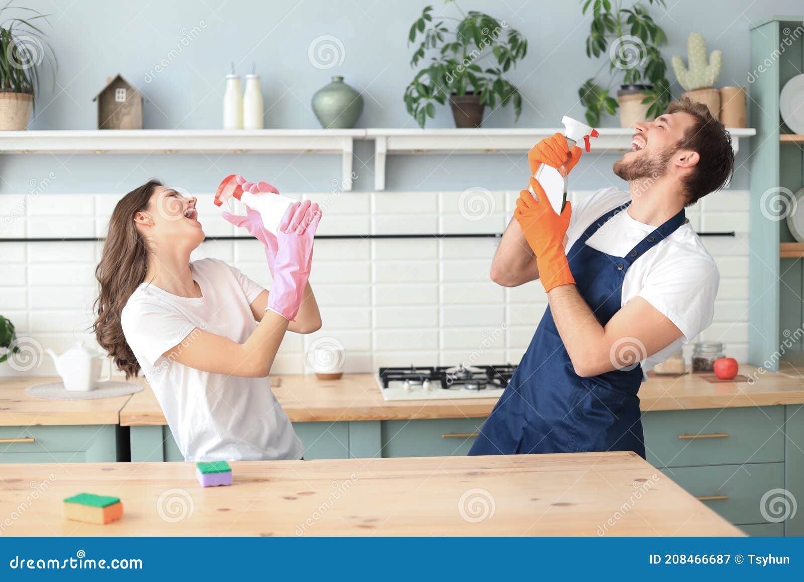 Happy Young Couple Doing Home Chores, Singing and Having Fun Stock ...