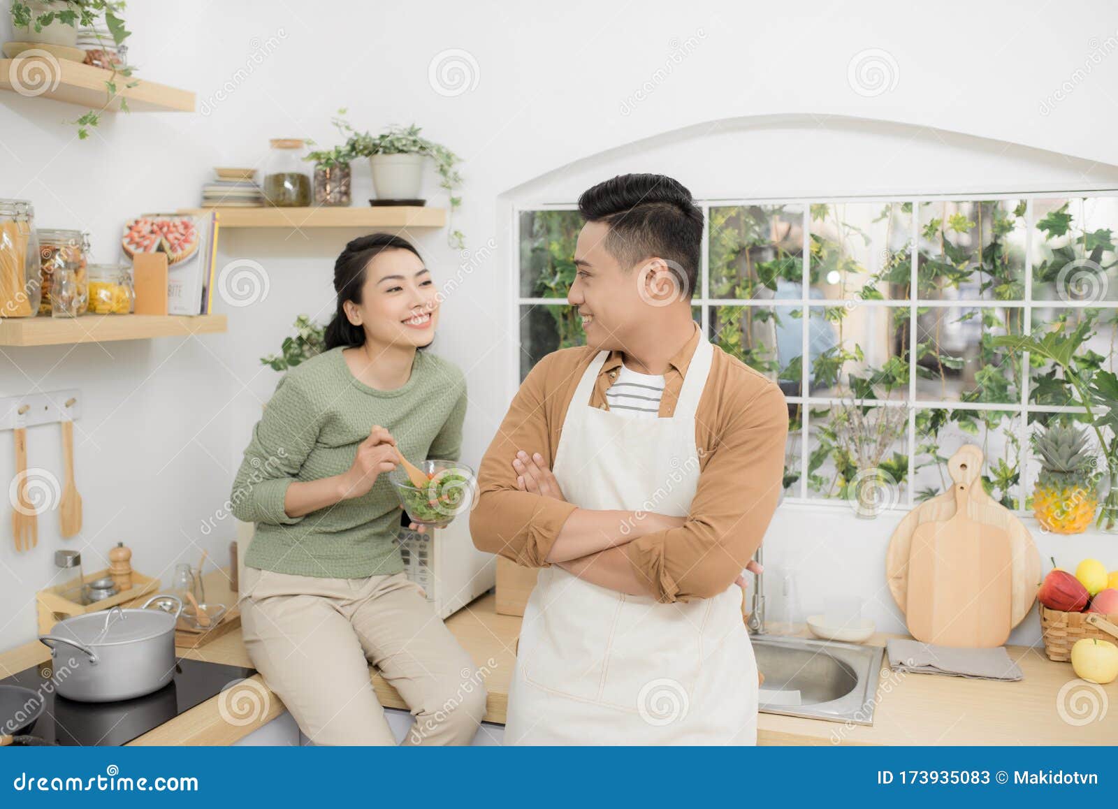 Happy Young Couple Eating and Talking in the Kitchen Stock Image ...
