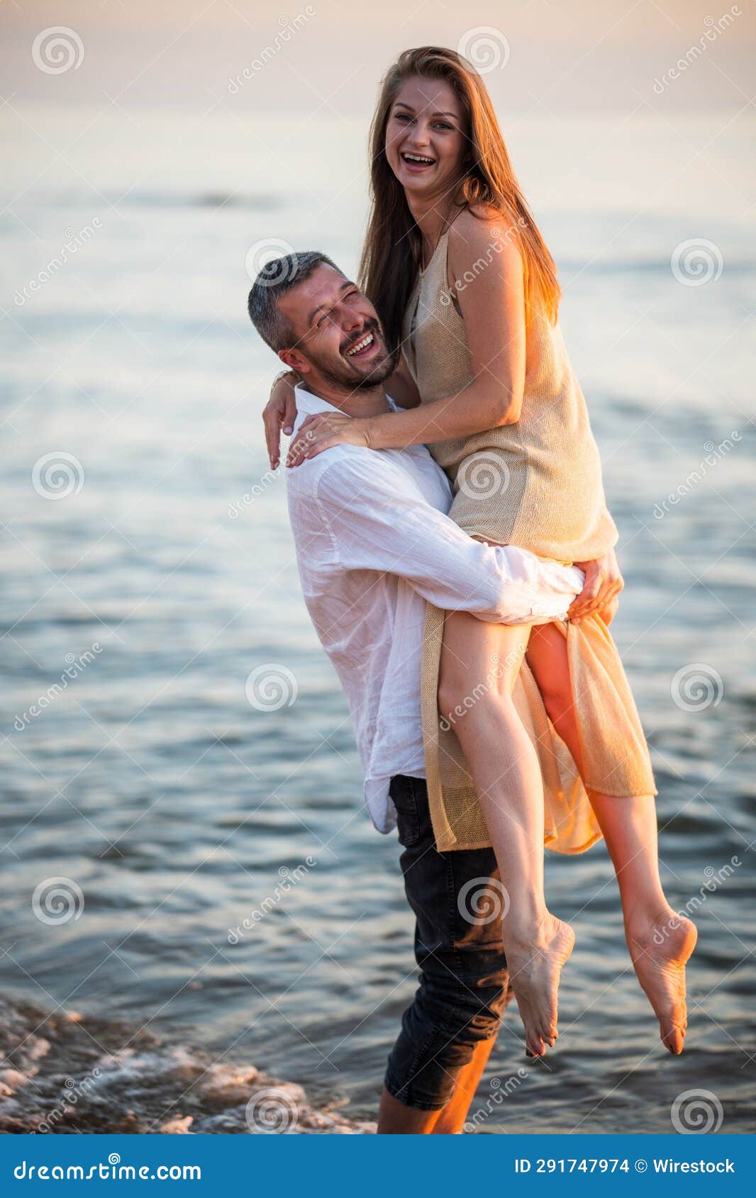 Happy Young Couple Embrace Standing on a Sandy Beach Stock Photo ...