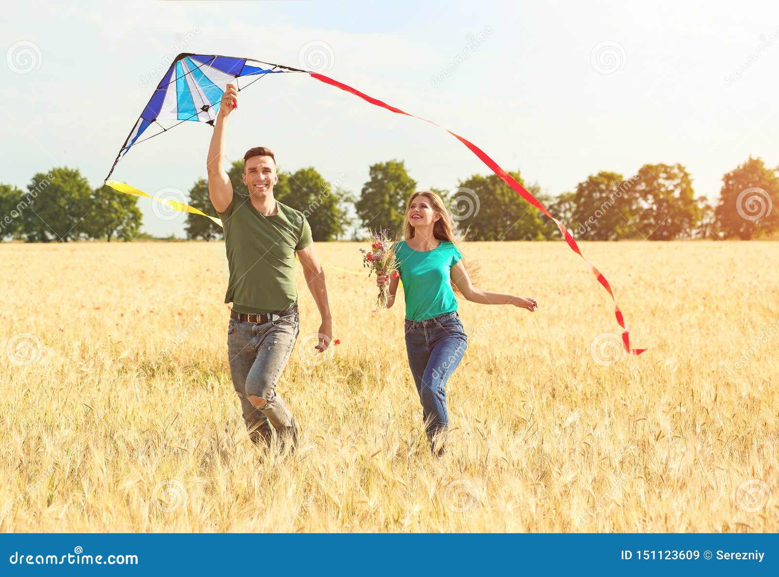 Happy Young Couple Flying Kite in a Field Stock Image - Image of ...