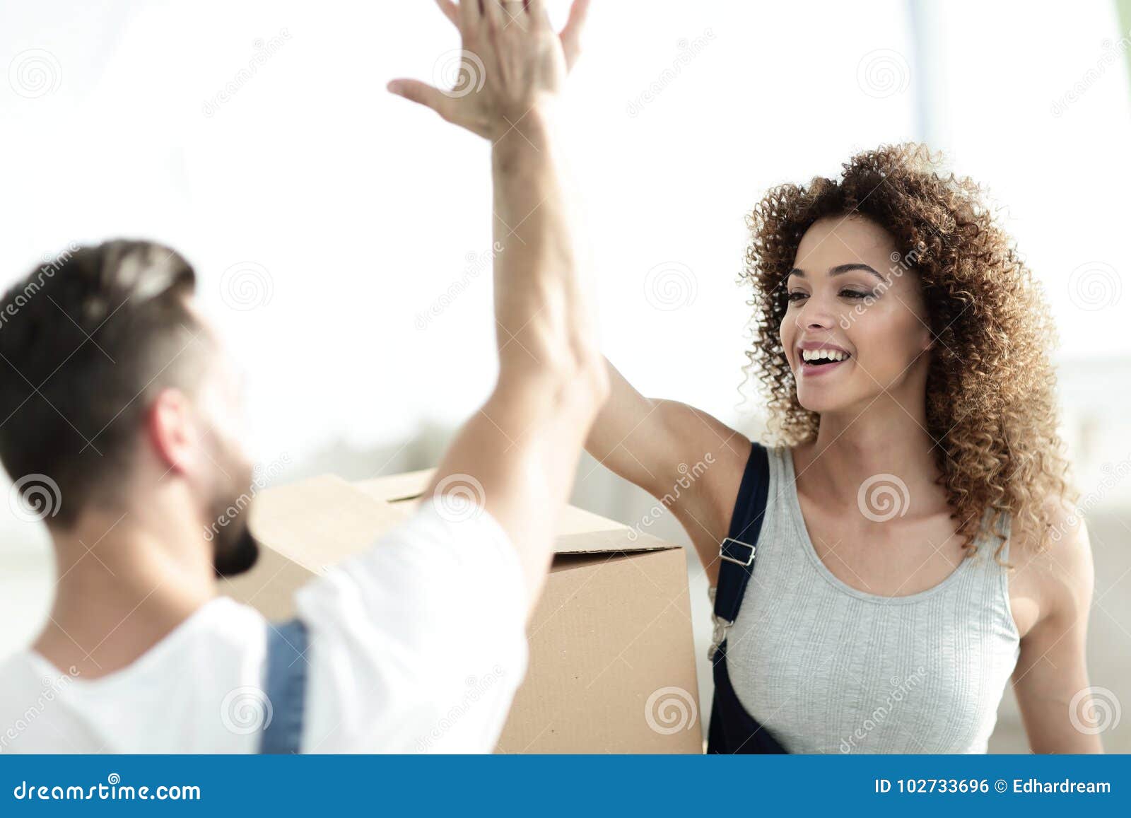 Happy and Young Couple Giving a High Five Stock Photo - Image of ...