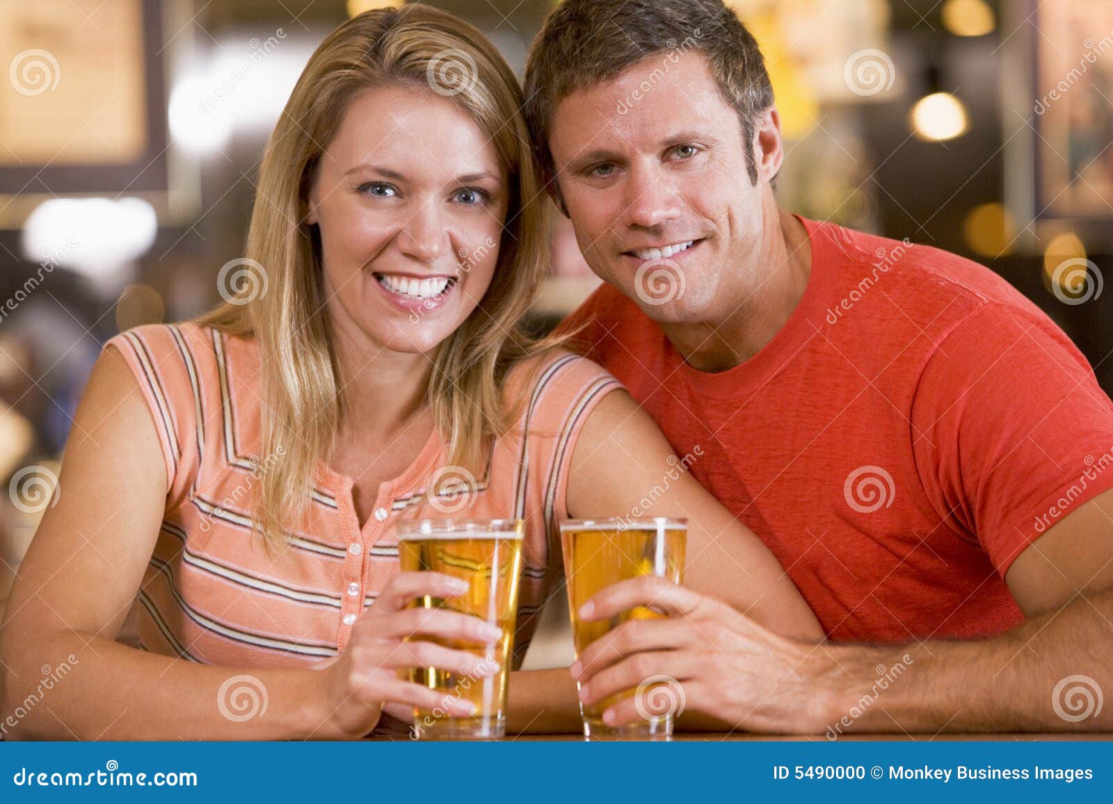 Happy Young Couple Having Beers at a Bar Stock Photo - Image of happy ...