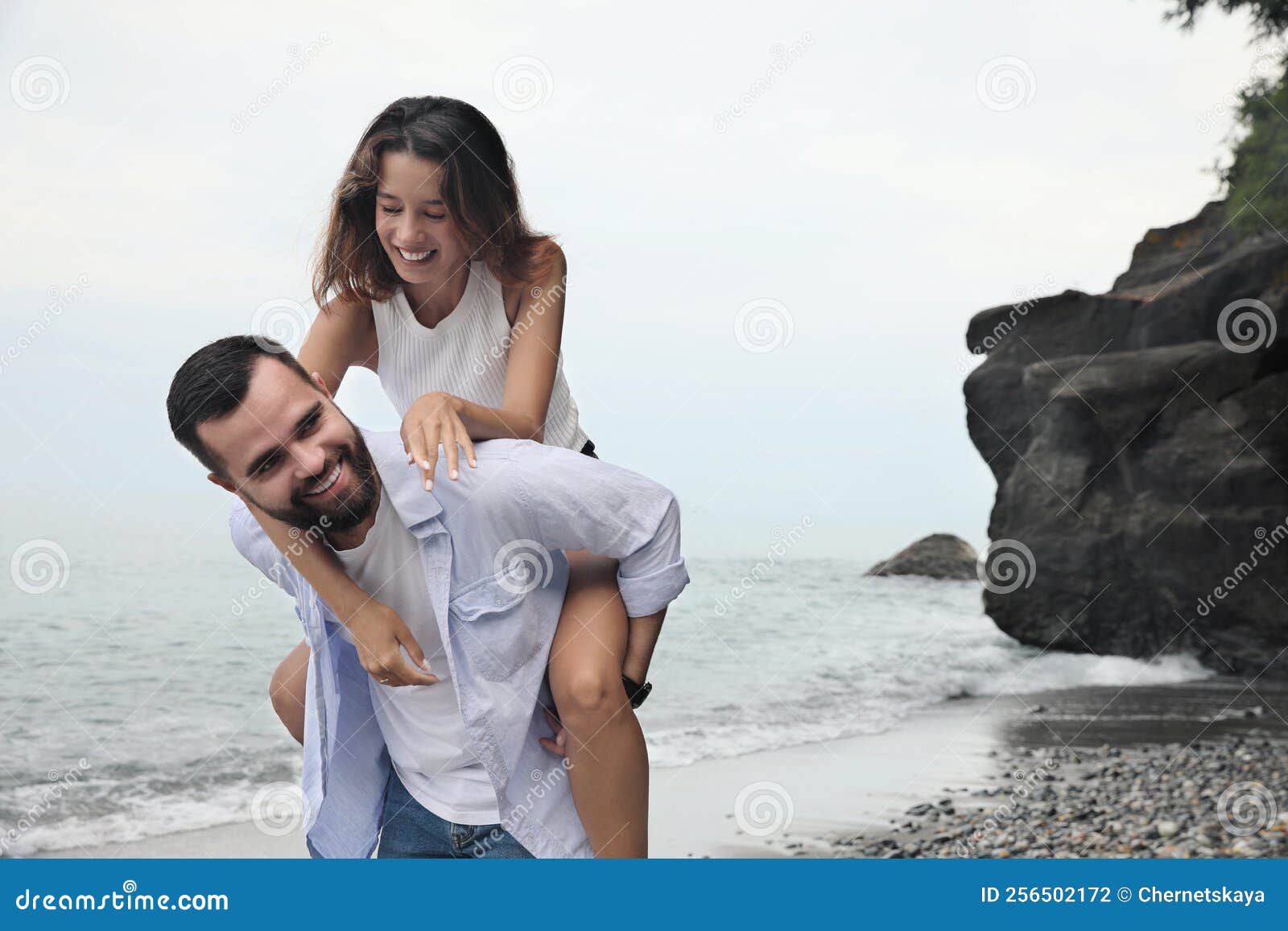 Happy Young Couple Having Fun on Beach Sea. Space for Text Stock Photo ...