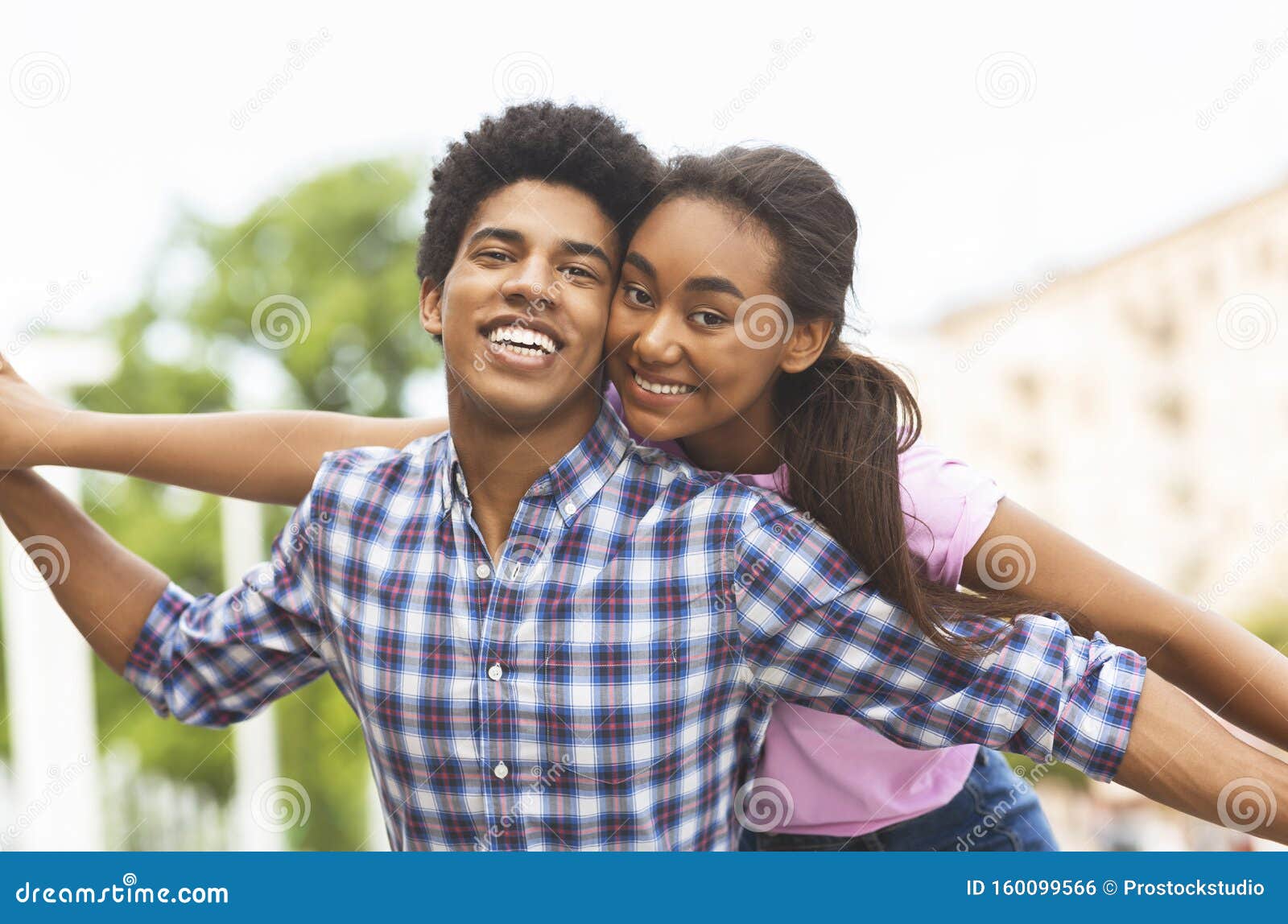 Happy Young Couple Having Fun and Fooling Around Together Outdoors ... Happy Young Couple Having Fun and Fooling Around Together Outdoors ...