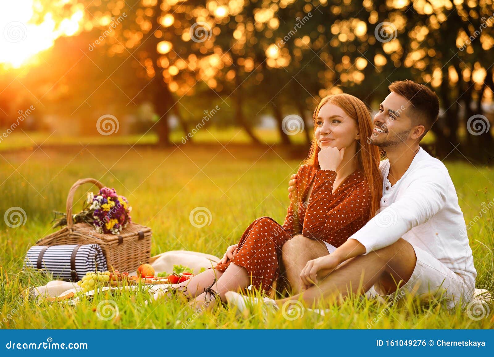 Happy Young Couple Having Picnic Stock Photo - Image of evening, happy ...