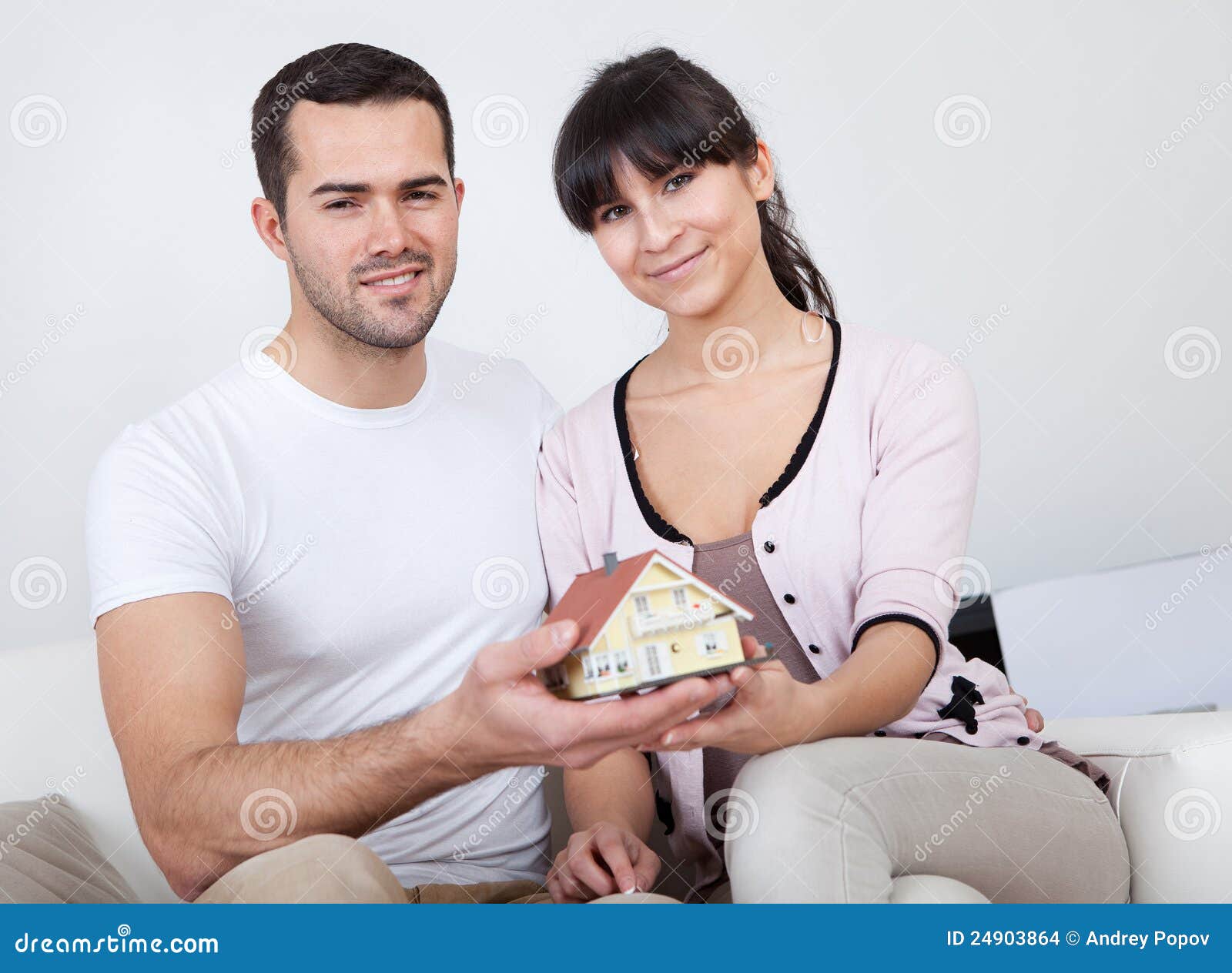 Happy Young Couple Holding a House Model Stock Photo - Image of couple ...