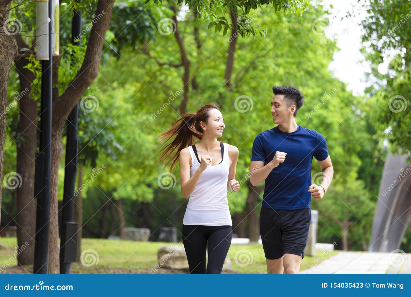 Happy Young Couple Jogging and Running in Park Stock Image - Image of ...
