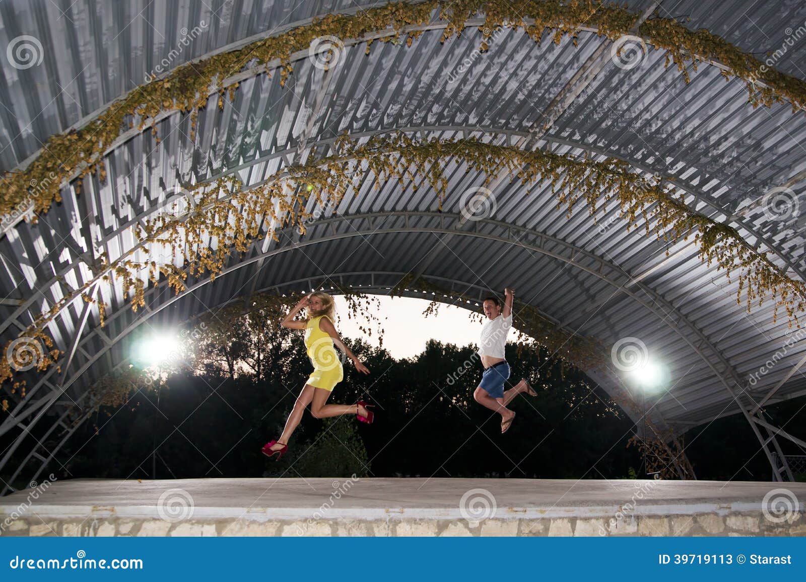 Happy Young Couple Jumping on Stage Stock Image - Image of family ...