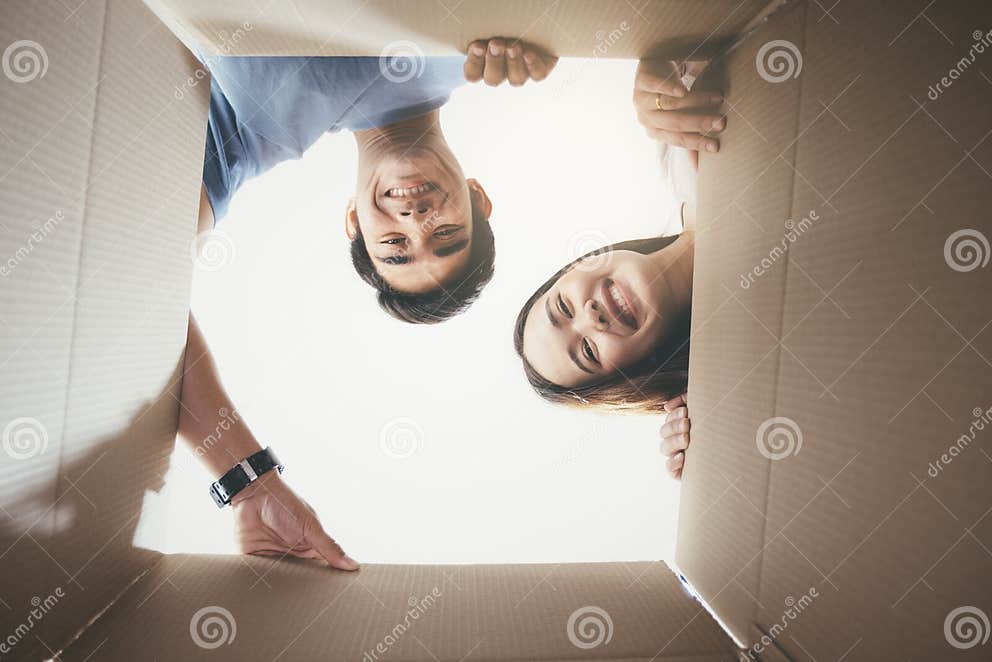 Happy Young Couple Looking Inside the Box. Stock Photo - Image of ...